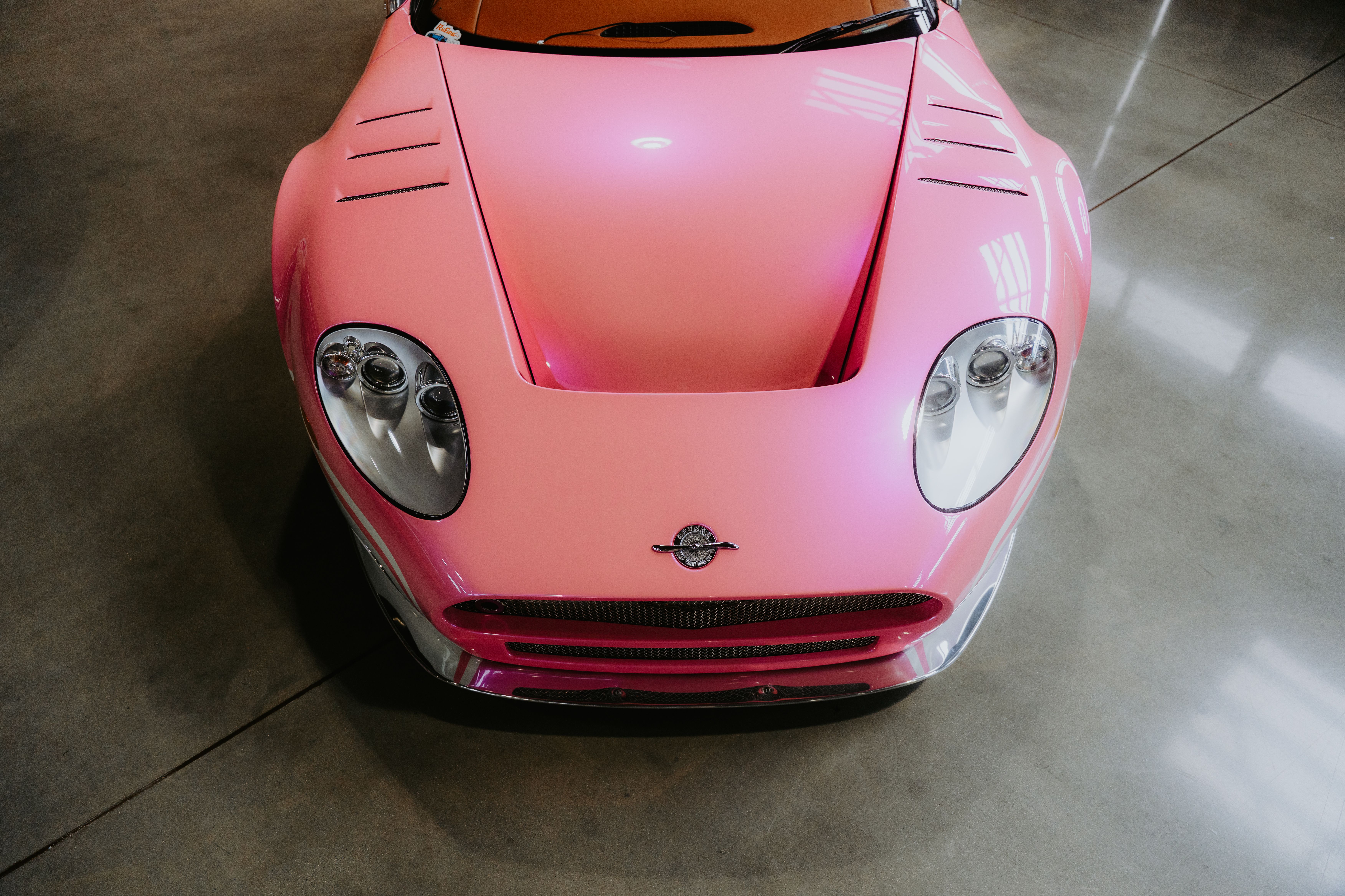 Pink Sports Car in Indoor Showroom · Free Stock Photo