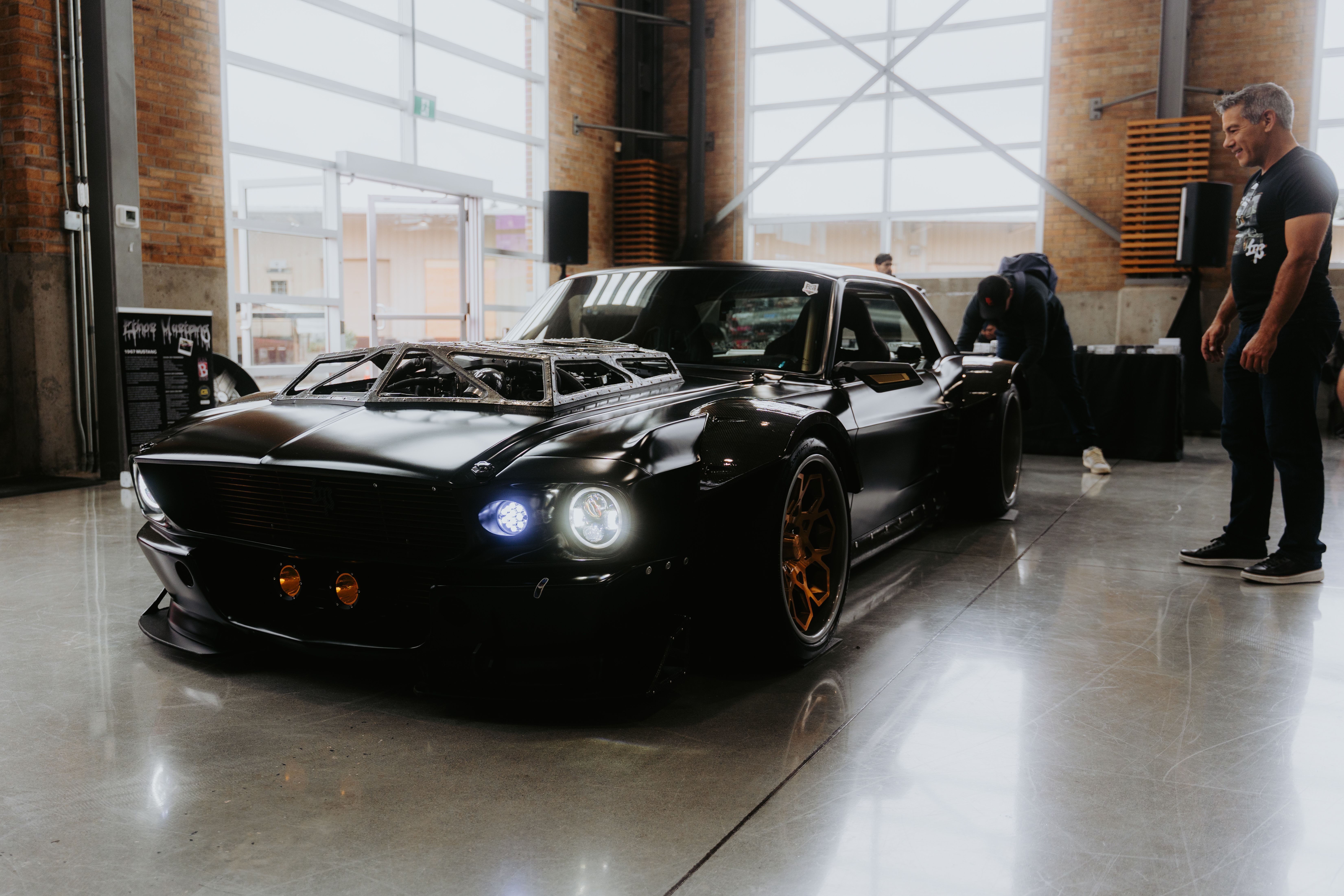 Sleek Black Racing Car in Modern Showroom · Free Stock Photo