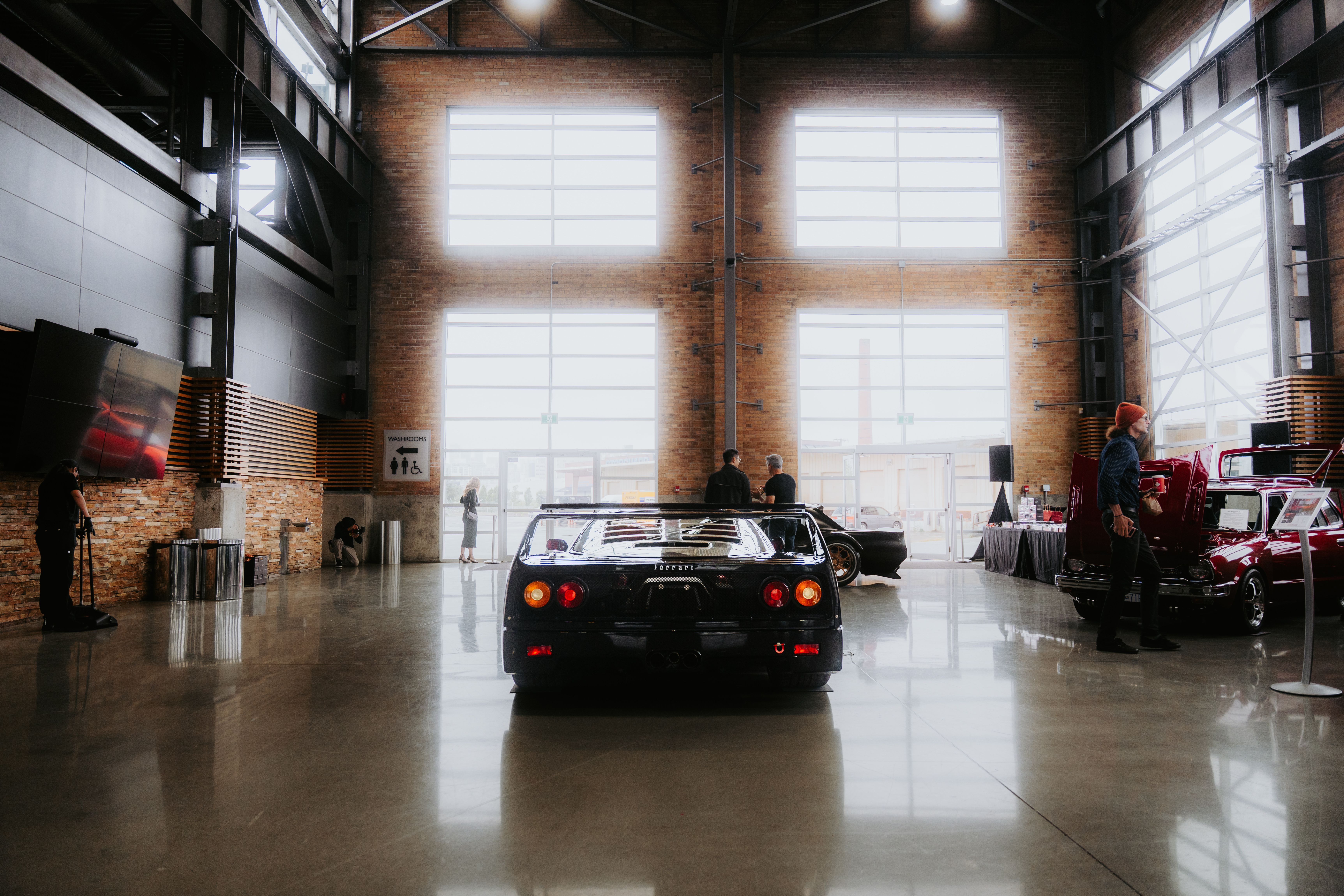 Vintage Car Exhibition in Industrial Venue · Free Stock Photo