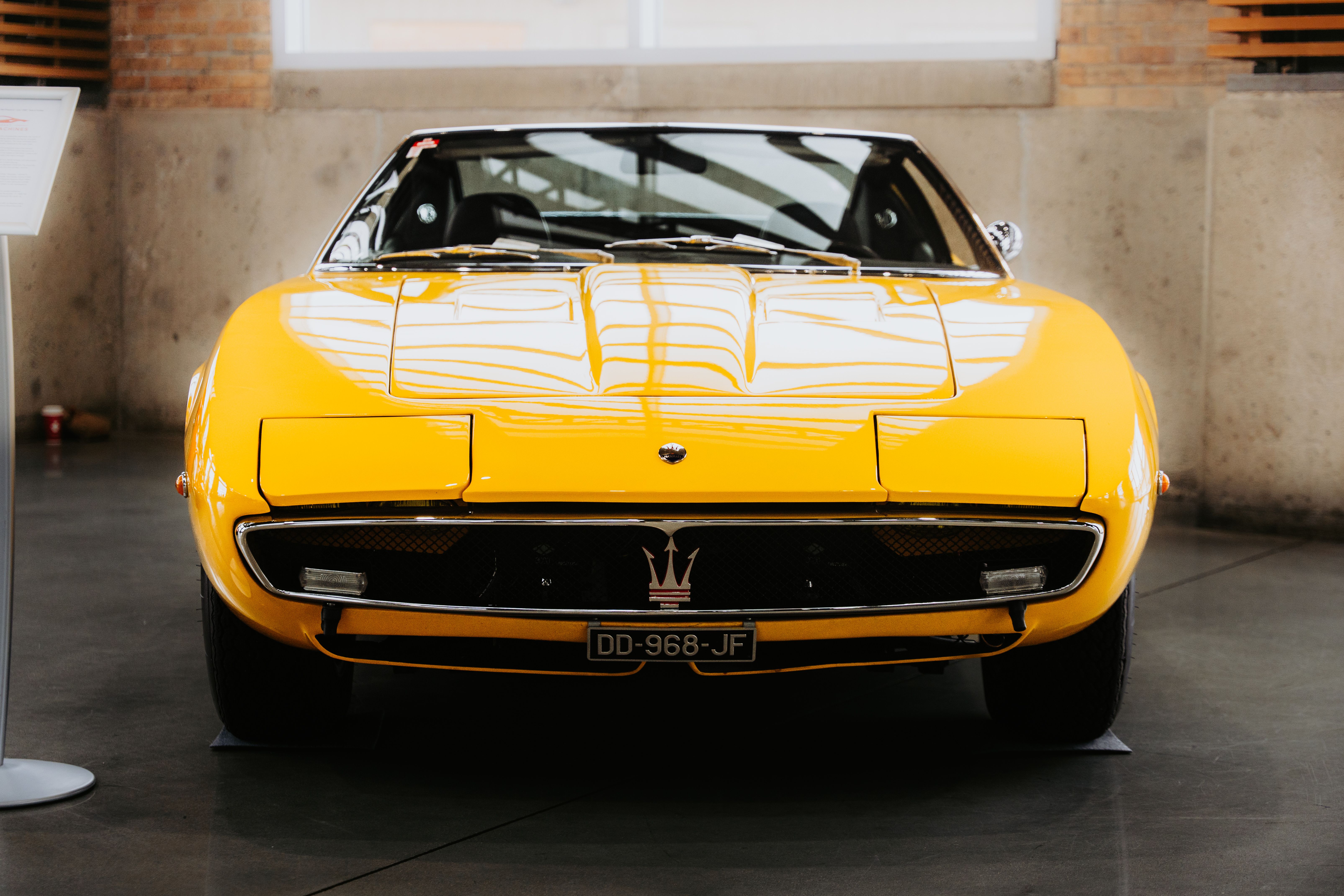 Stunning Vintage Yellow Sports Car Display Indoor · Free Stock Photo