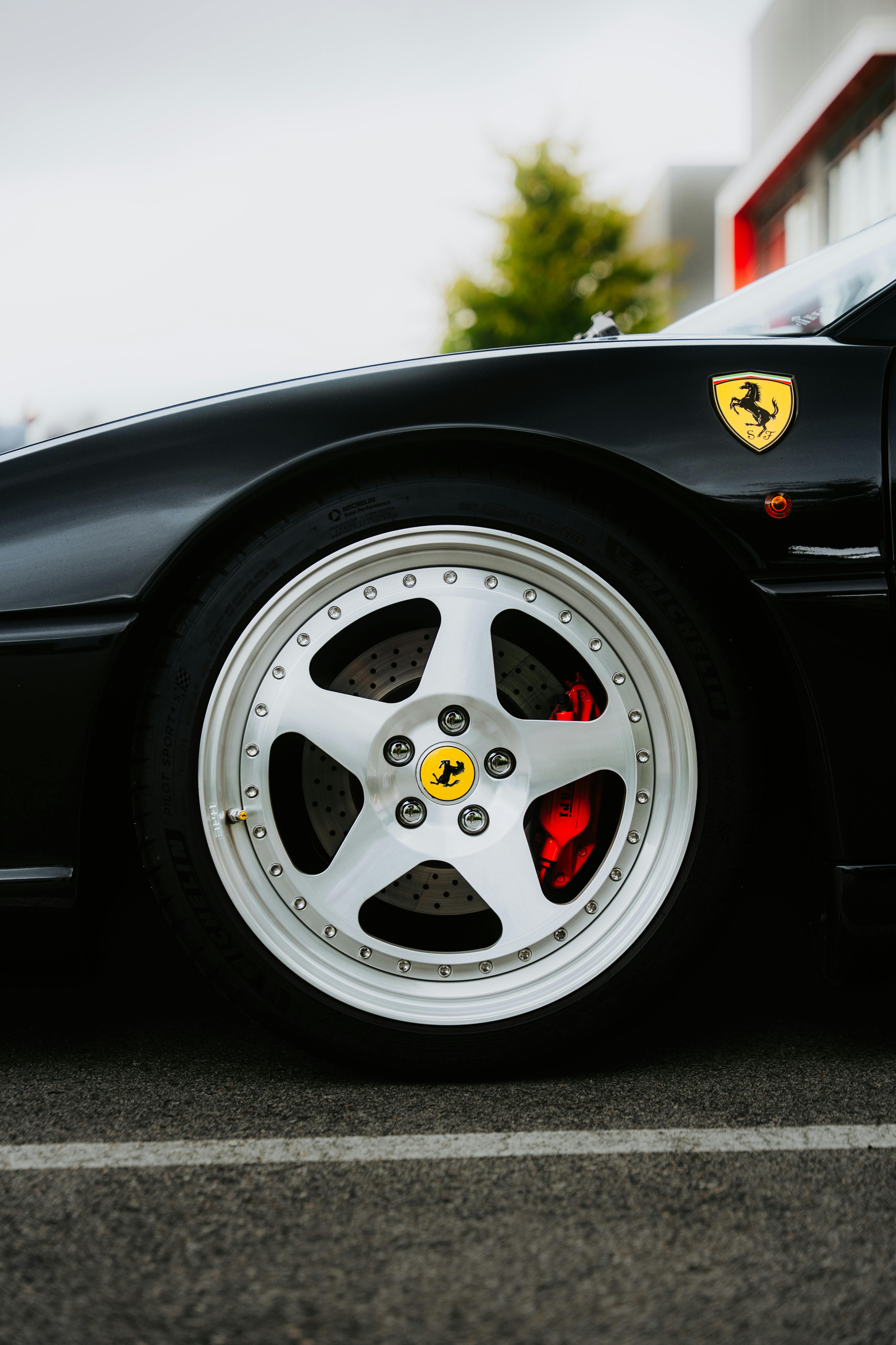 Close-up of Sporty Car Wheel with Red Brake Caliper · Free Stock Photo
