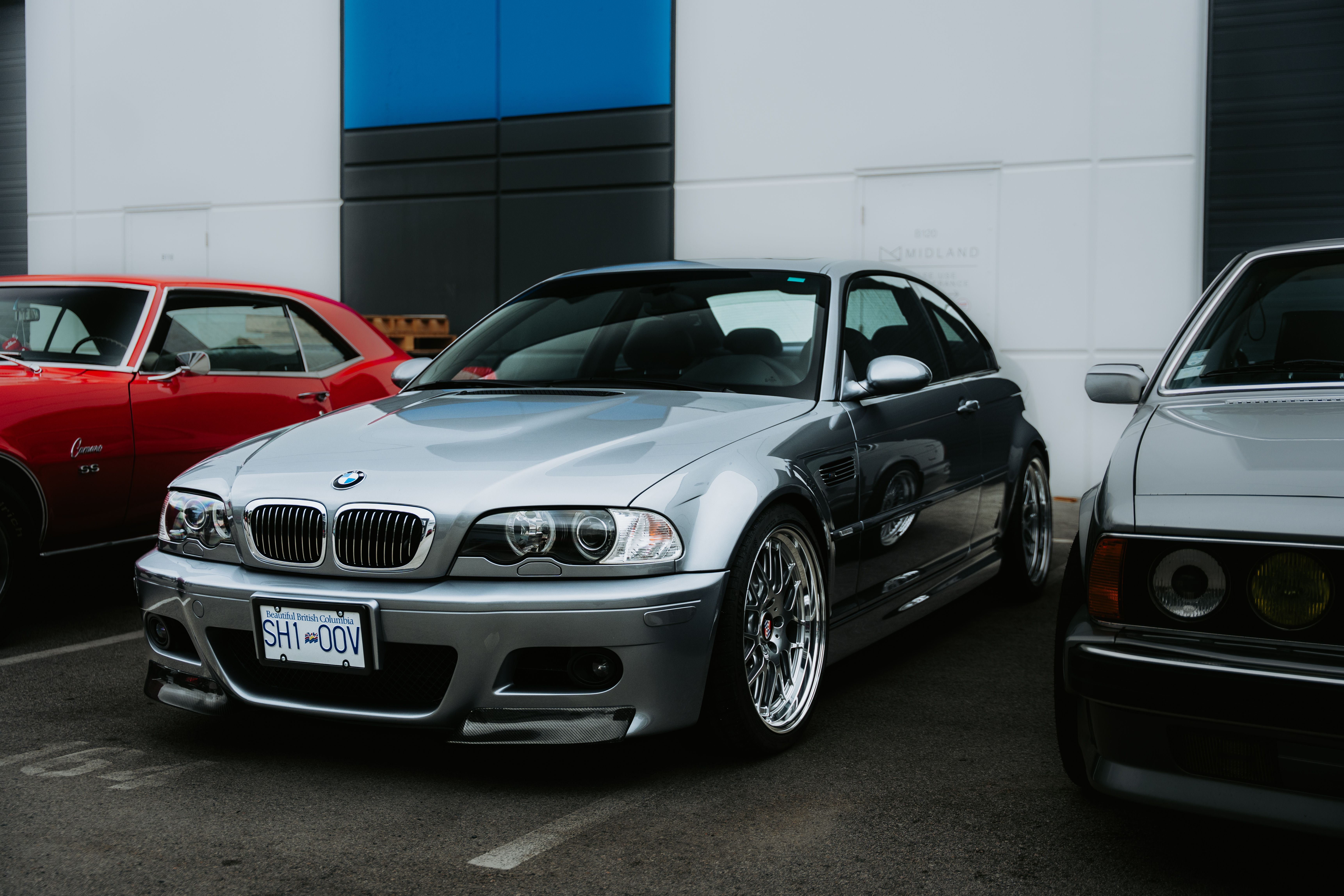 Vintage and Modern BMW Cars in Outdoor Parking · Free Stock Photo