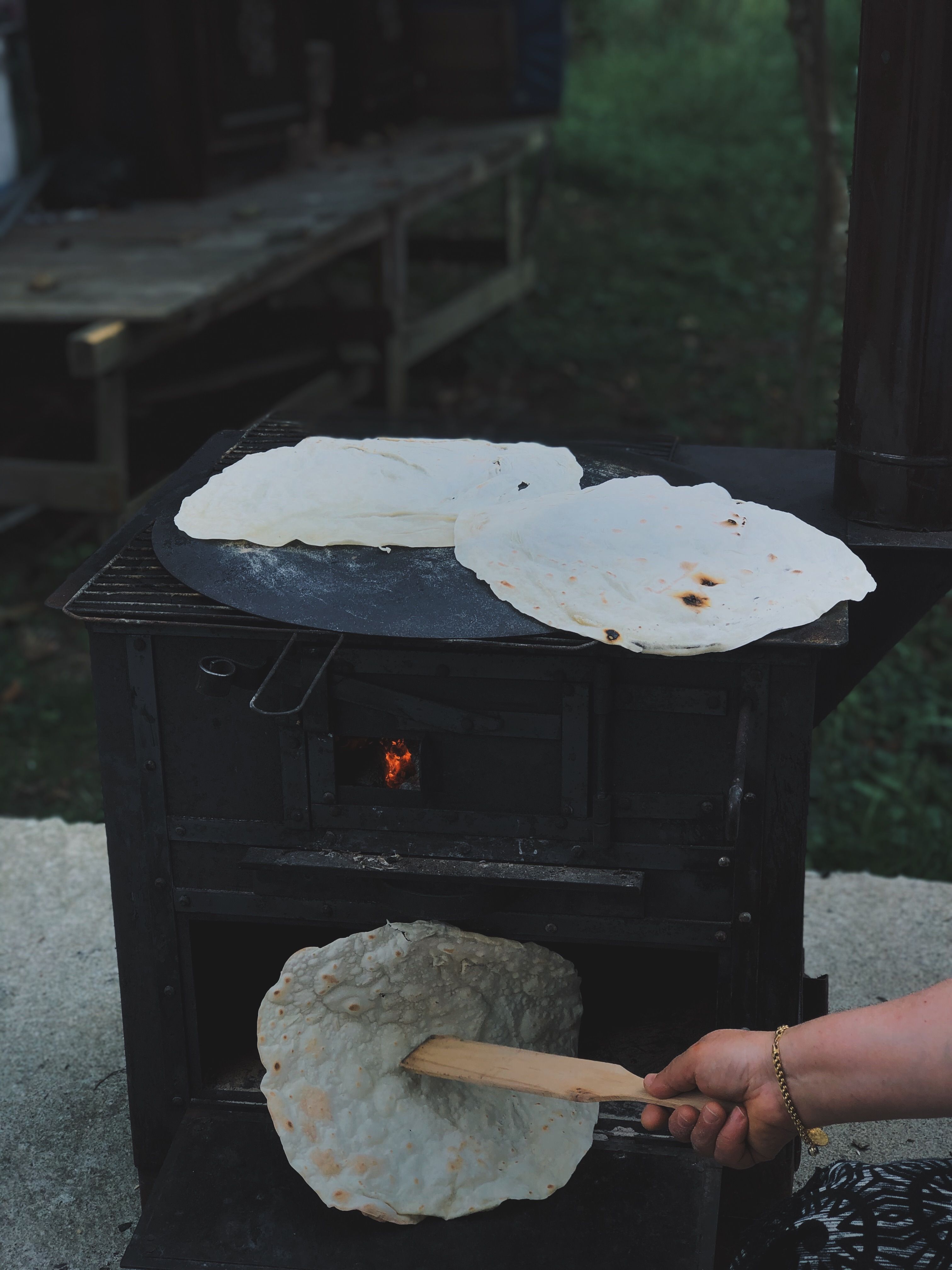 Rustic Bread Baking on Outdoor Wood Stove · Free Stock Photo