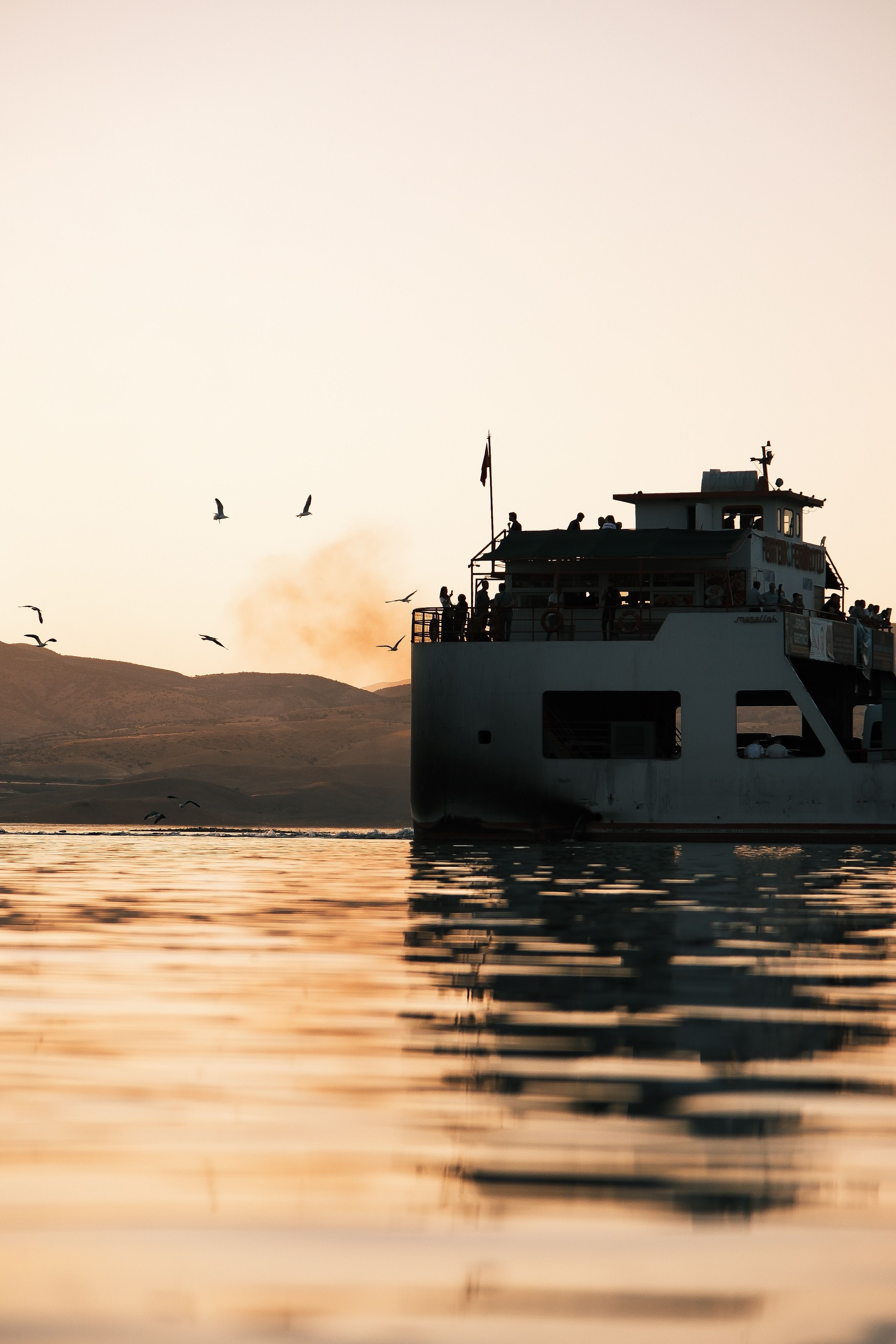 Ferry at Sunset with Birds Over Water · Free Stock Photo