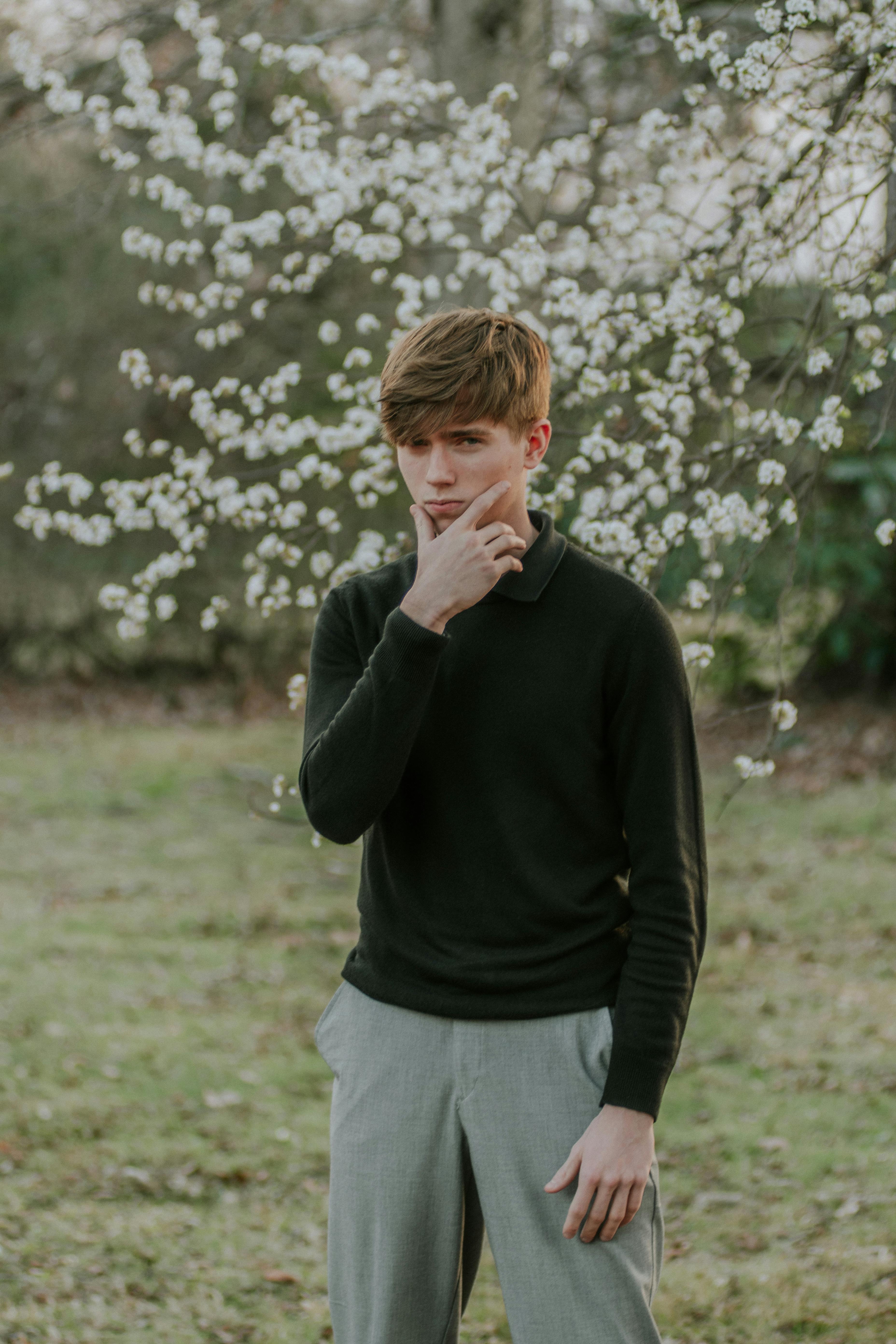 Contemplative Young Man in Spring Garden · Free Stock Photo