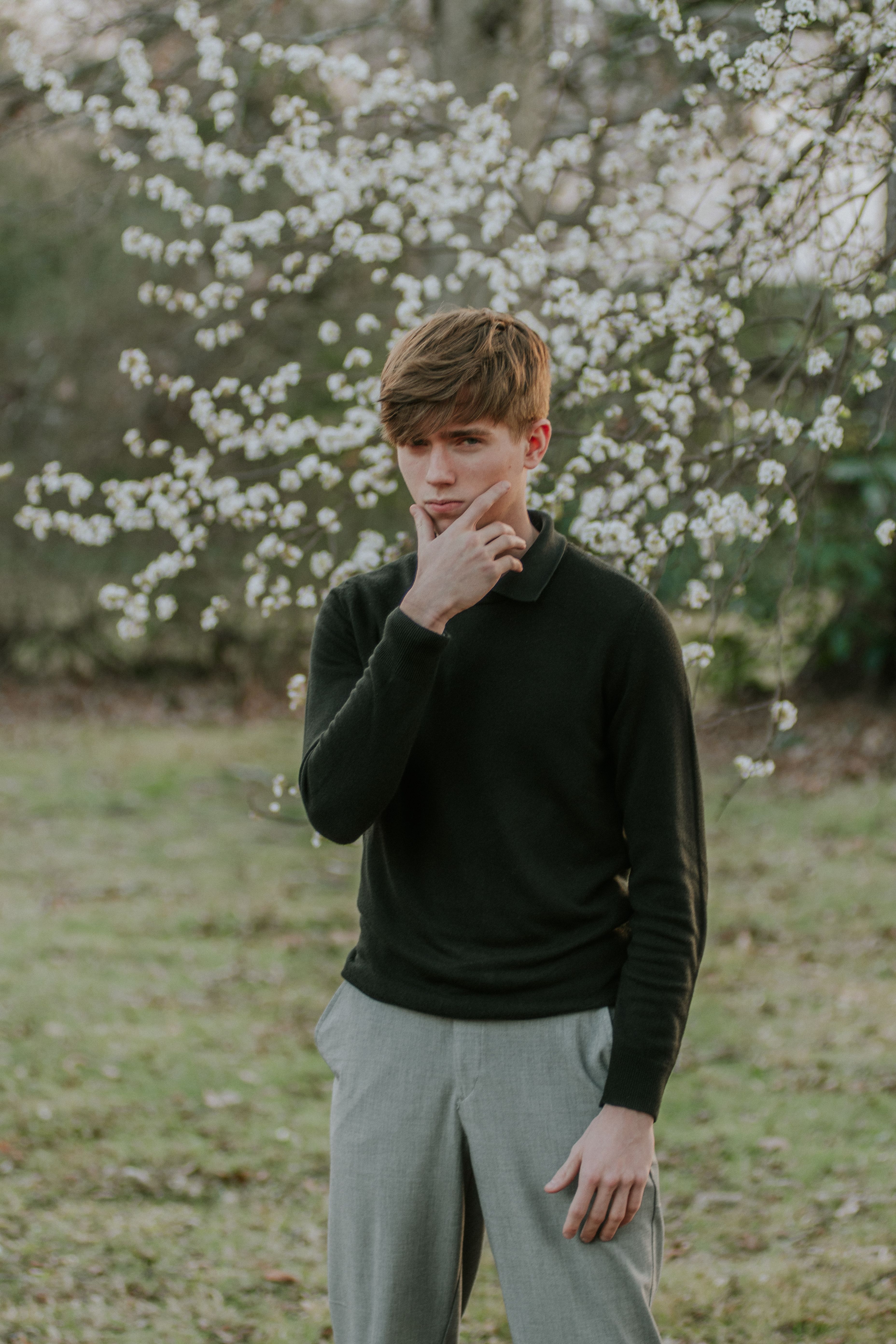 Contemplative Young Man in Spring Garden · Free Stock Photo