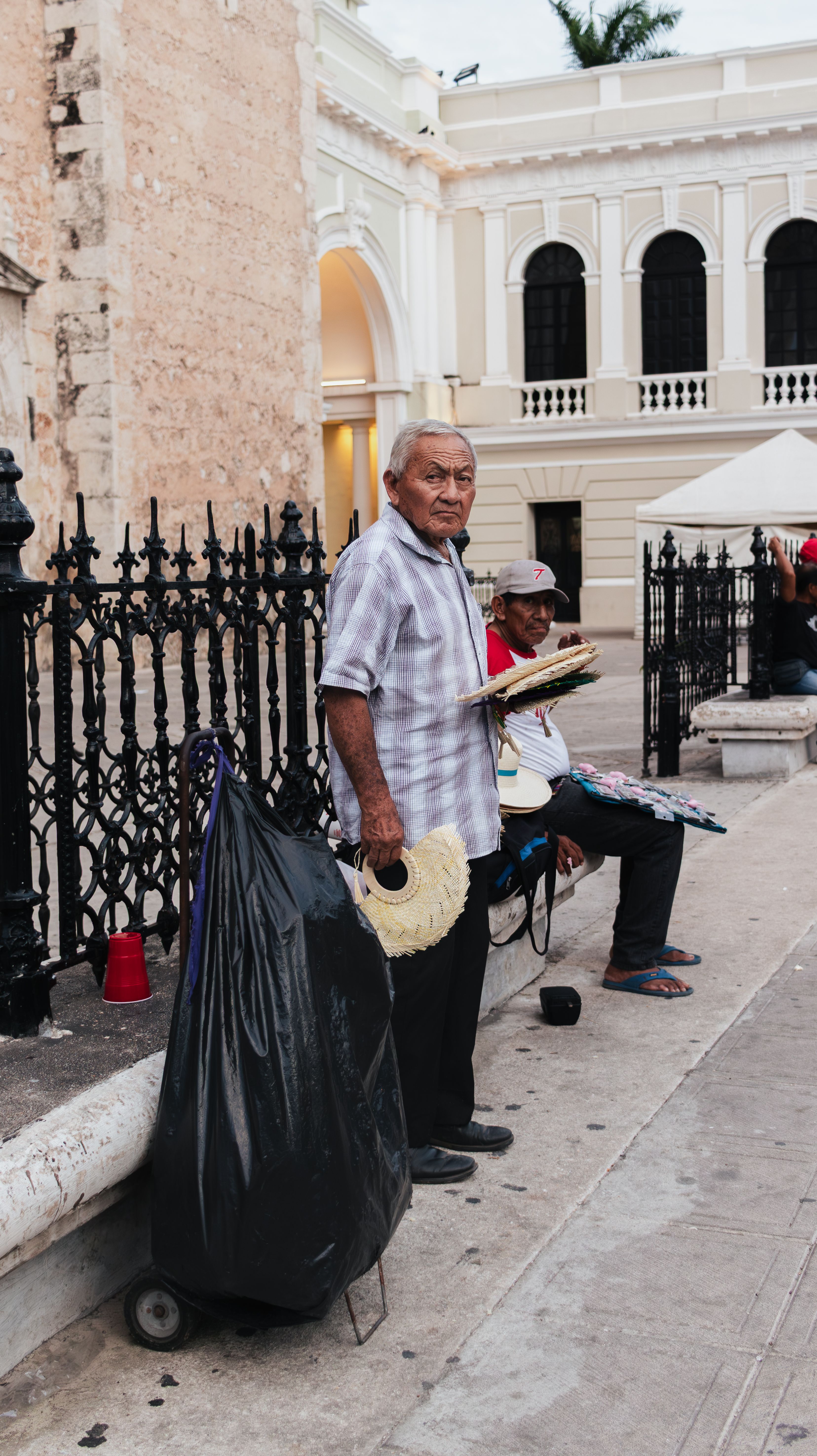 Elderly Street Vendor Selling Handmade Fans · Free Stock Photo