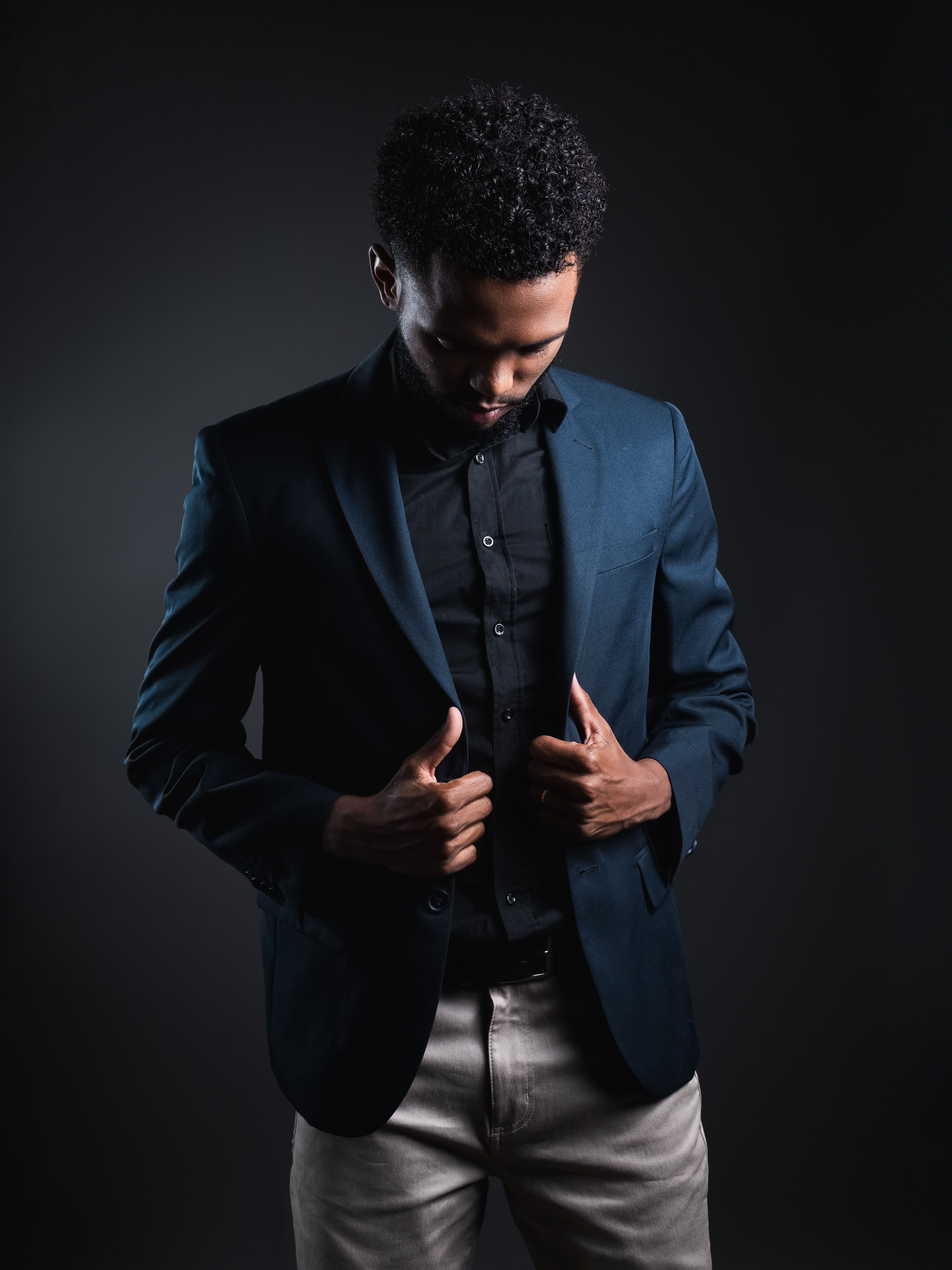 Stylish Young Man Adjusting Suit Jacket · Free Stock Photo