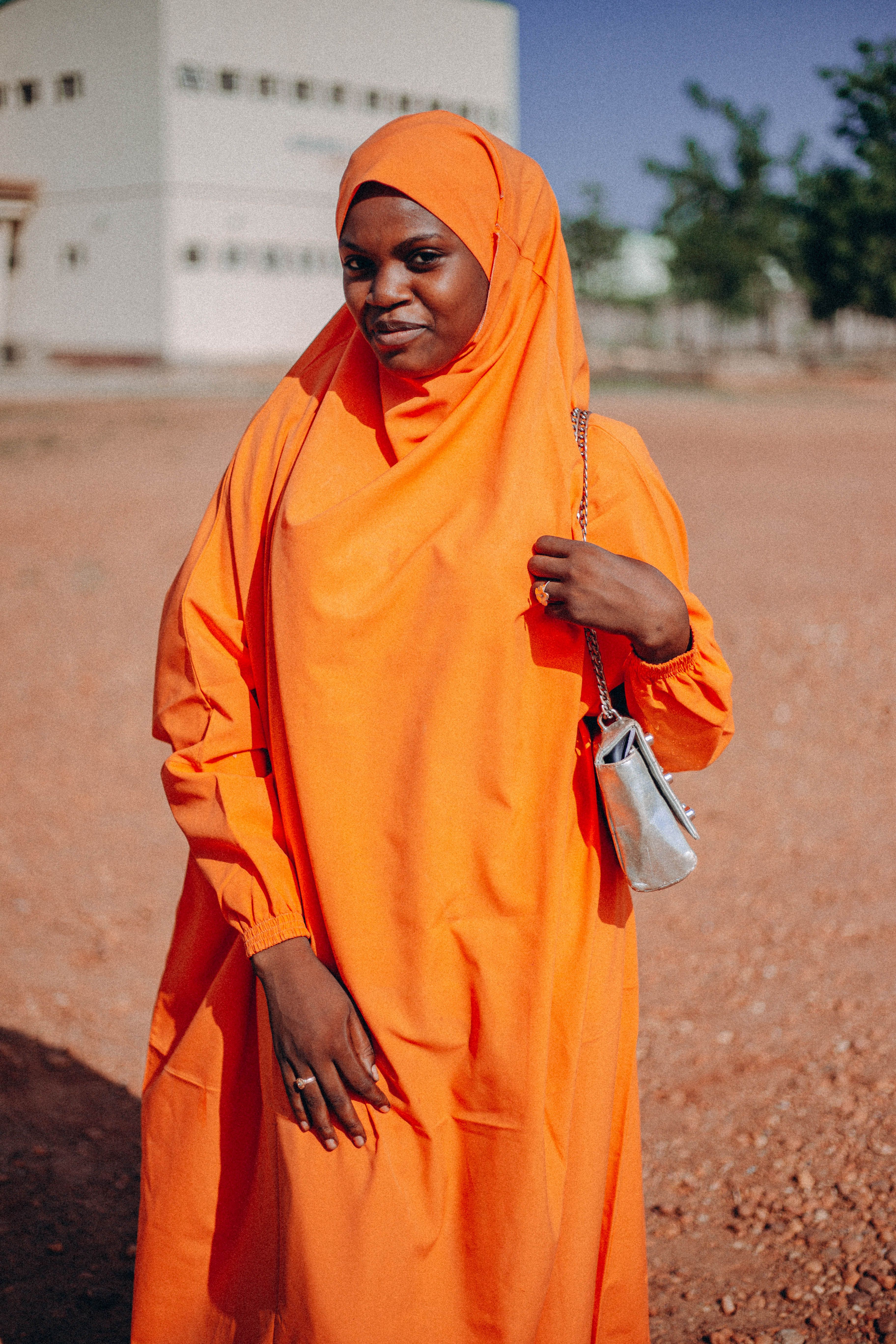 Young Woman in Bright Orange Hijab Outdoors · Free Stock Photo
