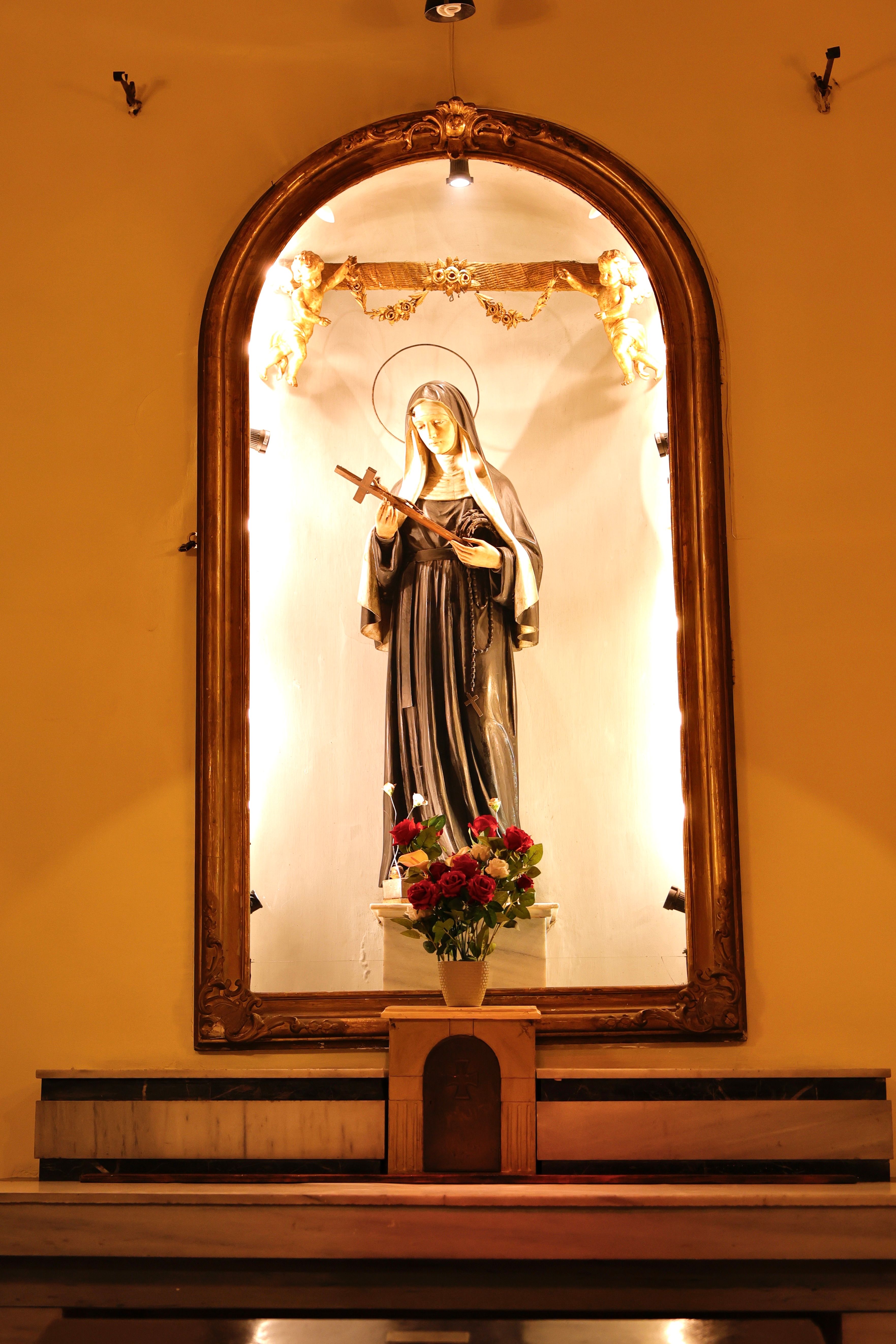 Statue of Saint with Halo in Lit Niche · Free Stock Photo