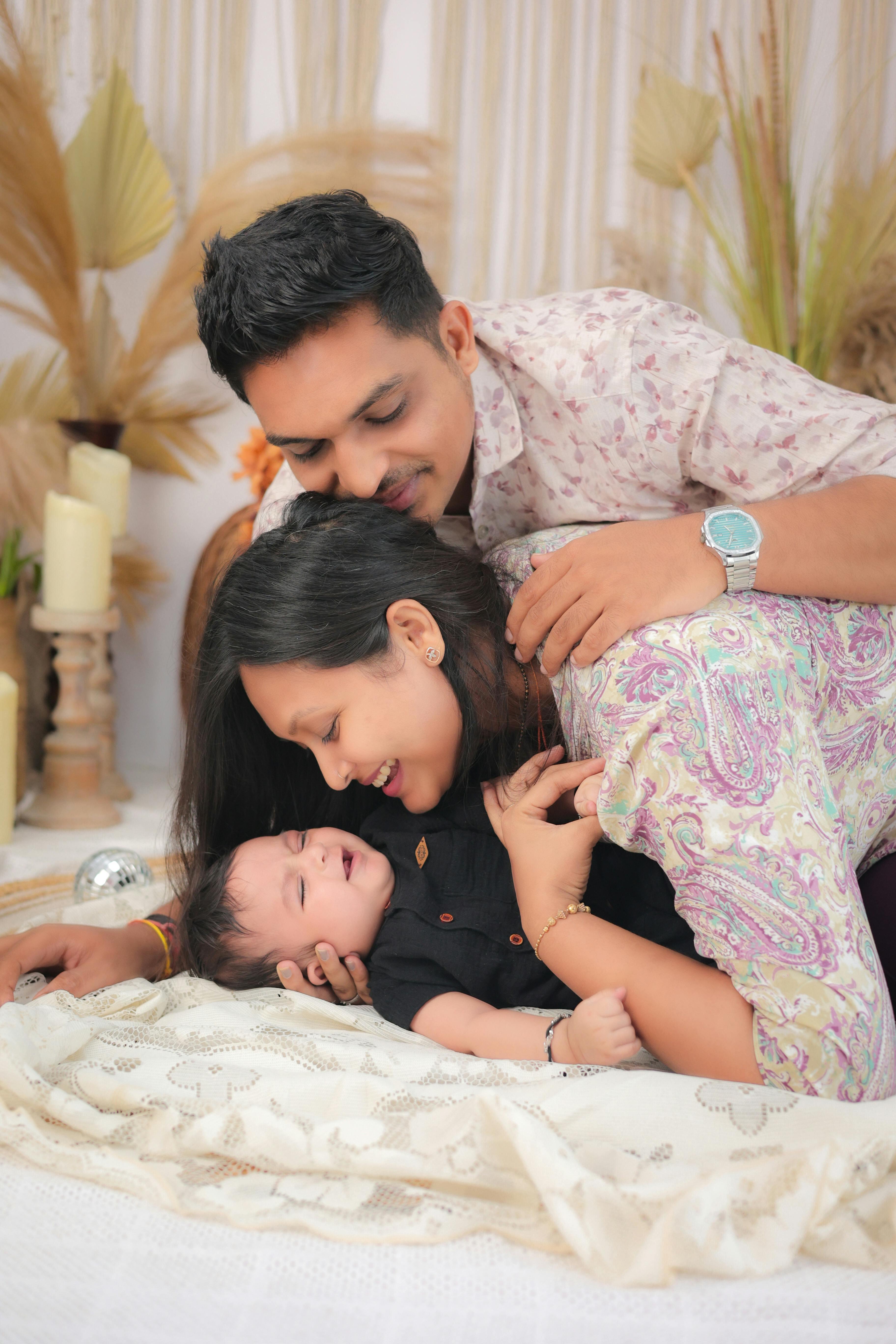 Joyful Family Cuddle with Smiling Baby · Free Stock Photo