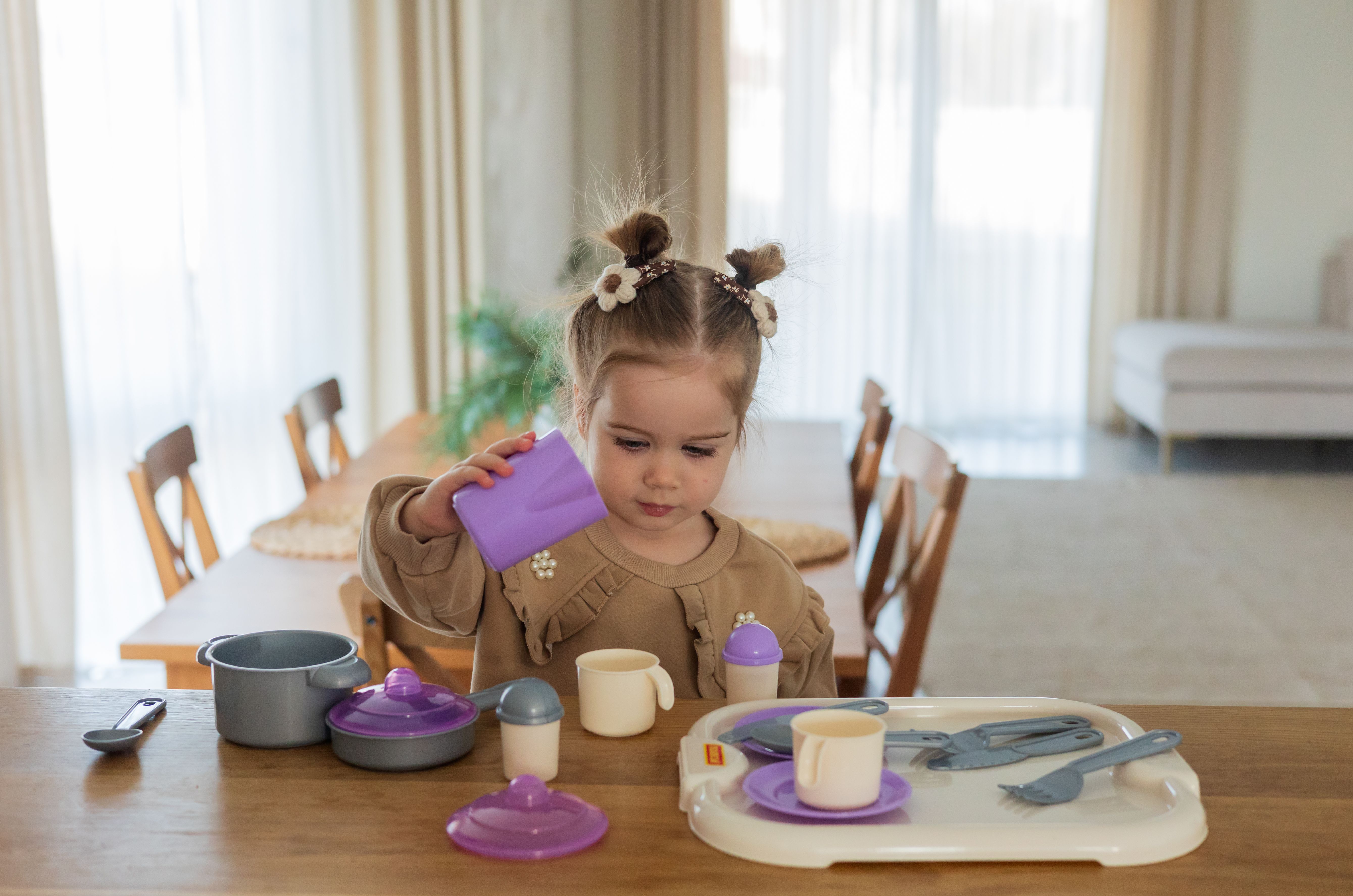 Little Girl Playing with Toy Tea Set Indoors · Free Stock Photo