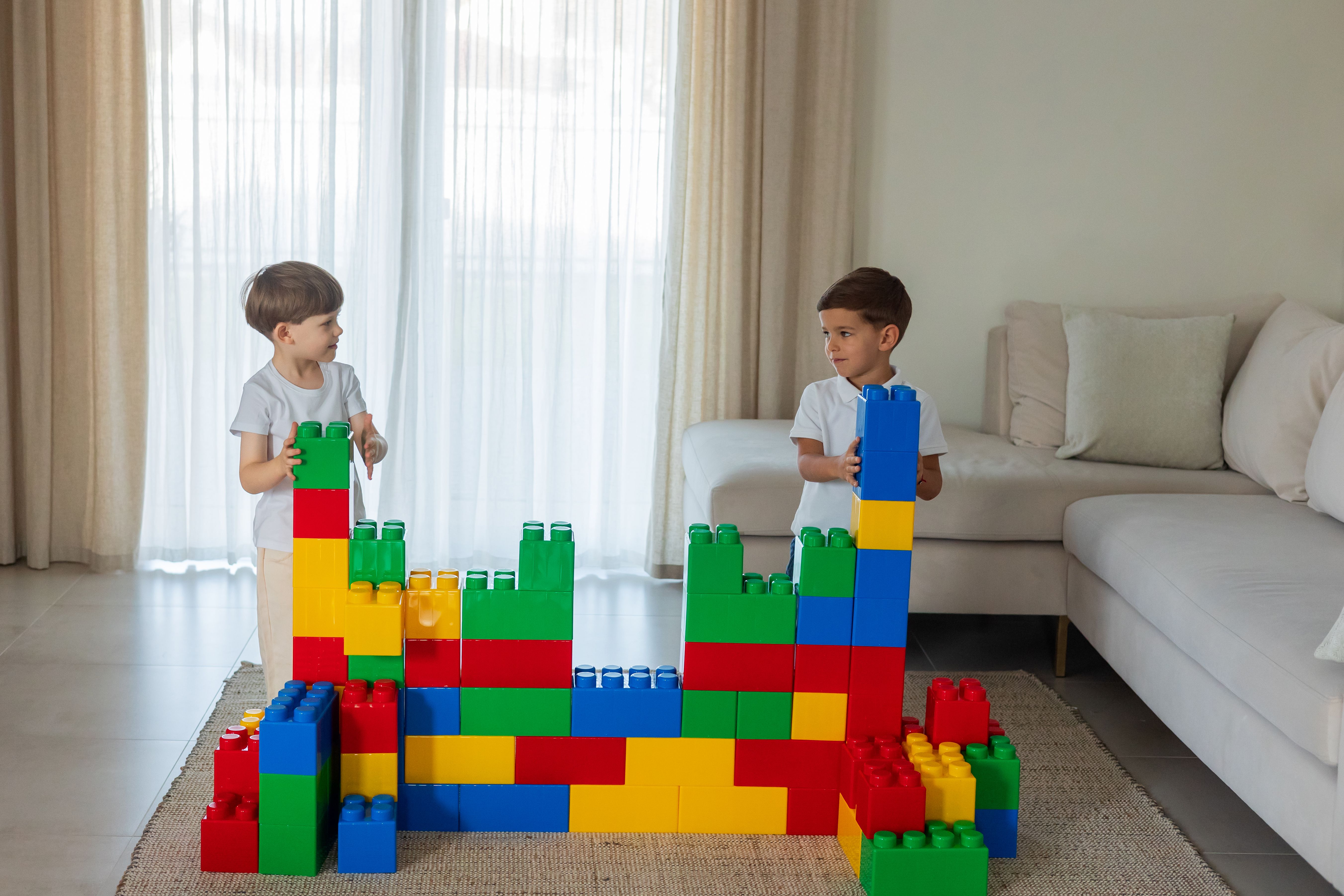 Children Playing with Colorful Building Blocks Indoors · Free Stock Photo