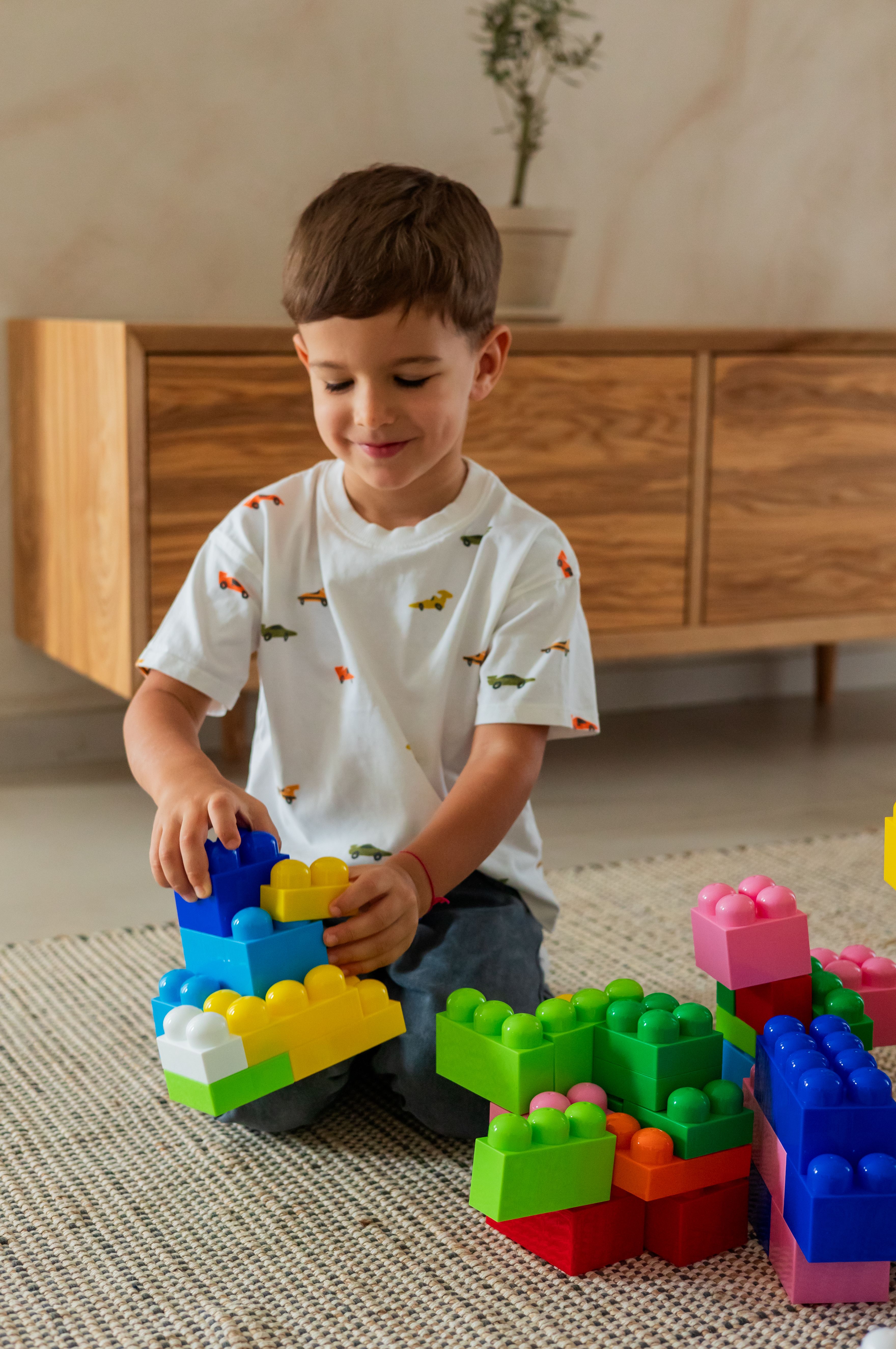 Young Boy Building Colorful Toy Blocks at Home · Free Stock Photo