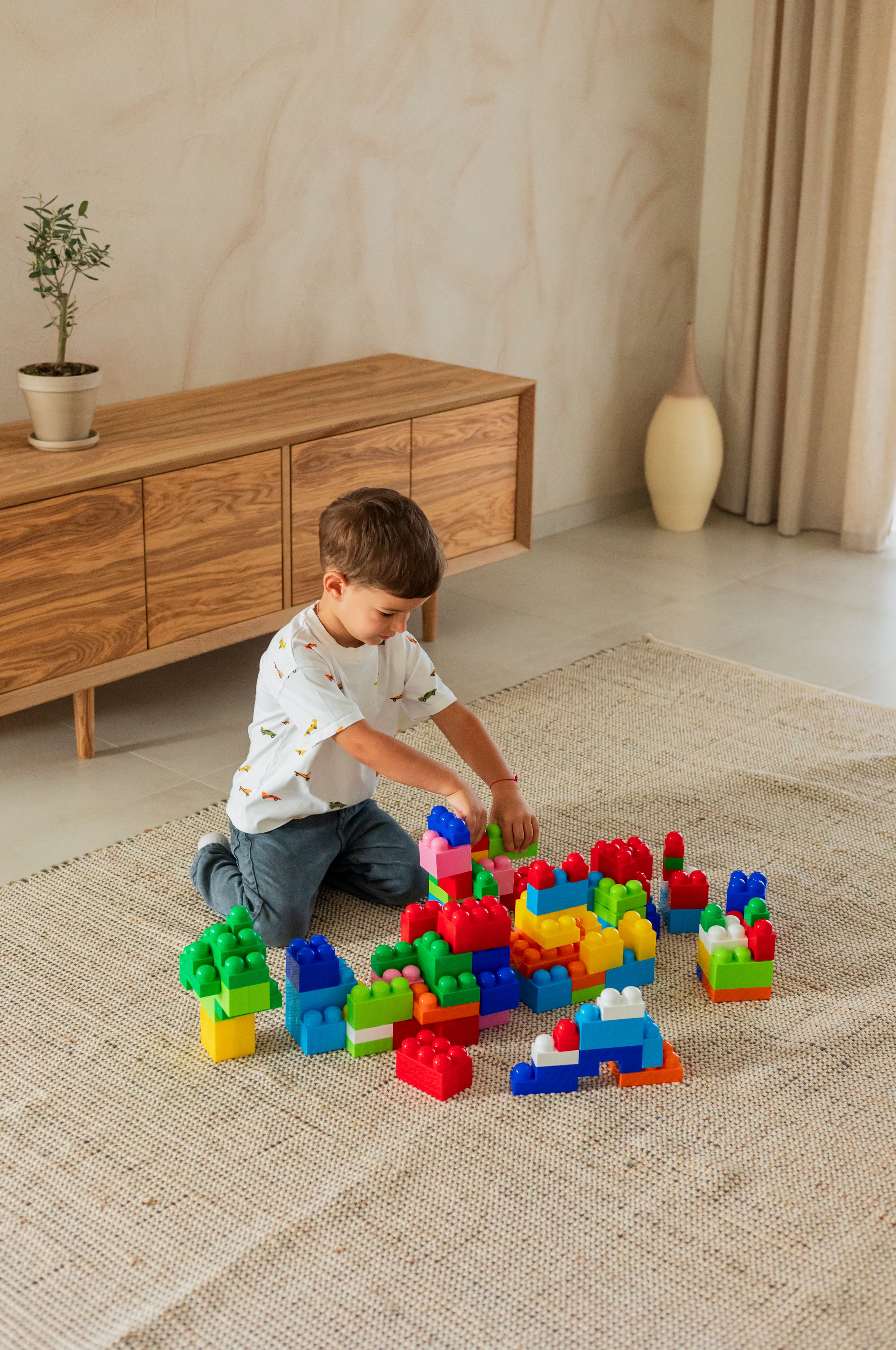 Child Playing with Colorful Building Blocks Indoors · Free Stock Photo