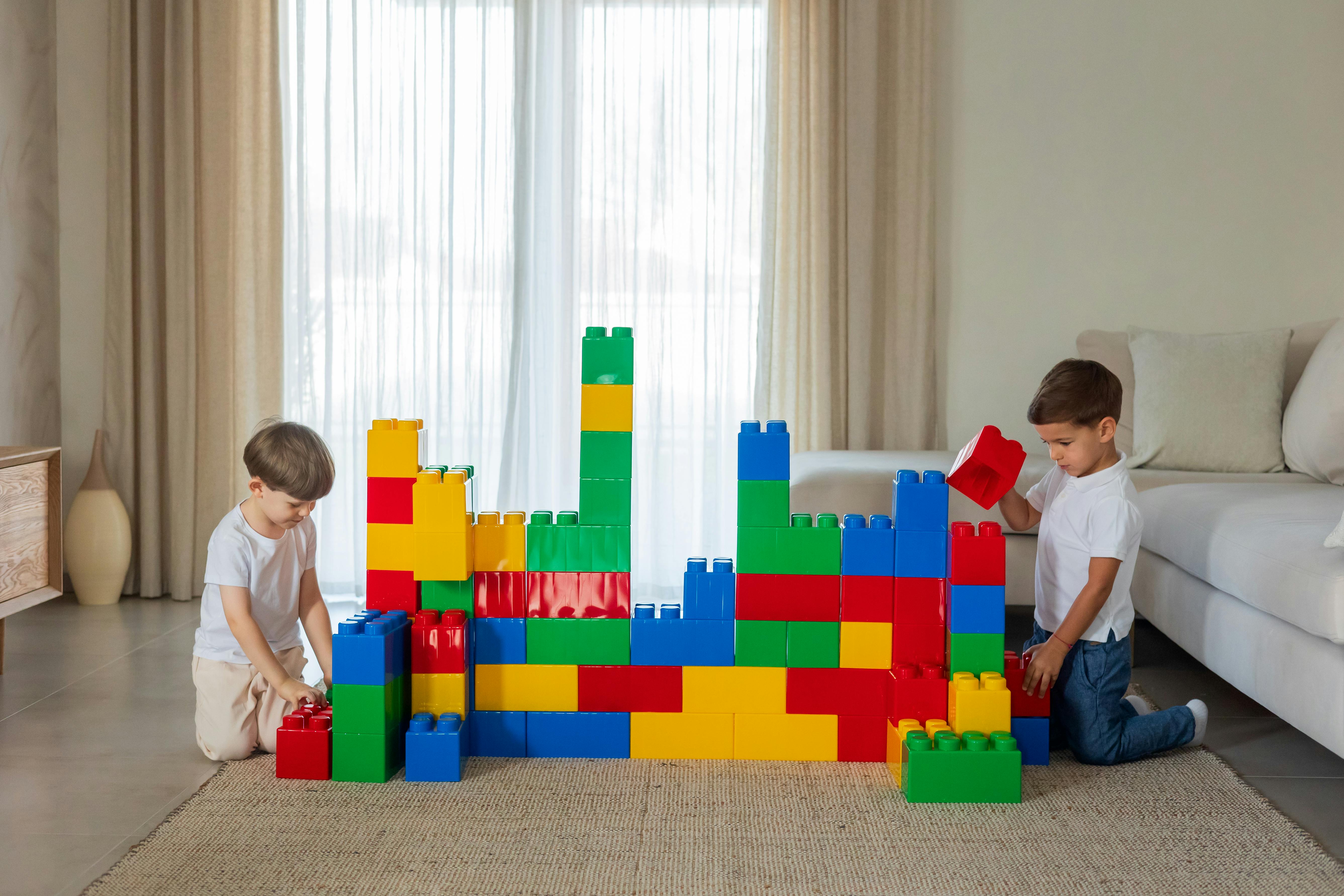 Children Playing with Colorful Building Blocks Indoors · Free Stock Photo