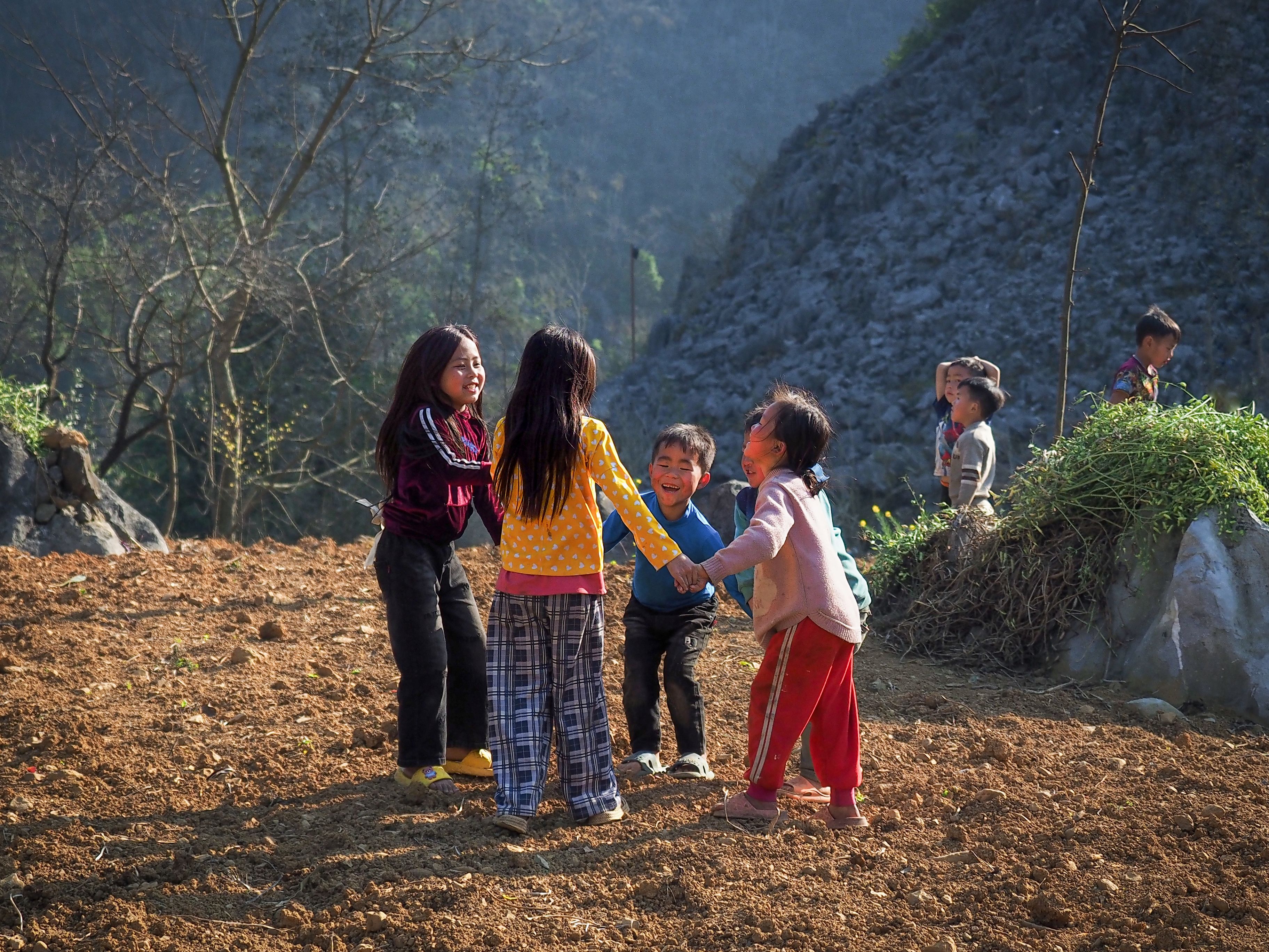 Children Playing Outdoors in Rural Setting · Free Stock Photo