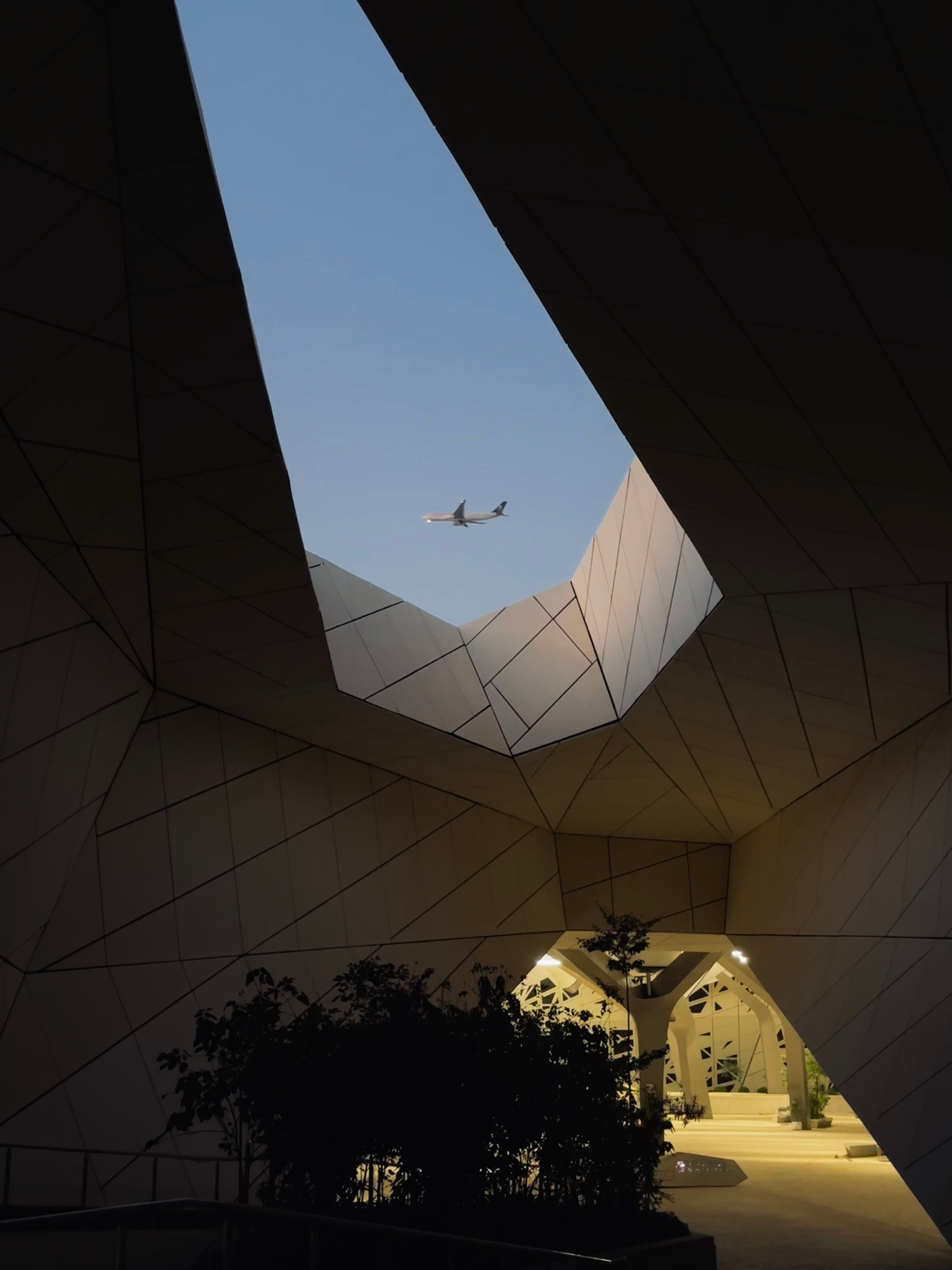 Abstract Architecture with Airplane in Sky · Free Stock Photo