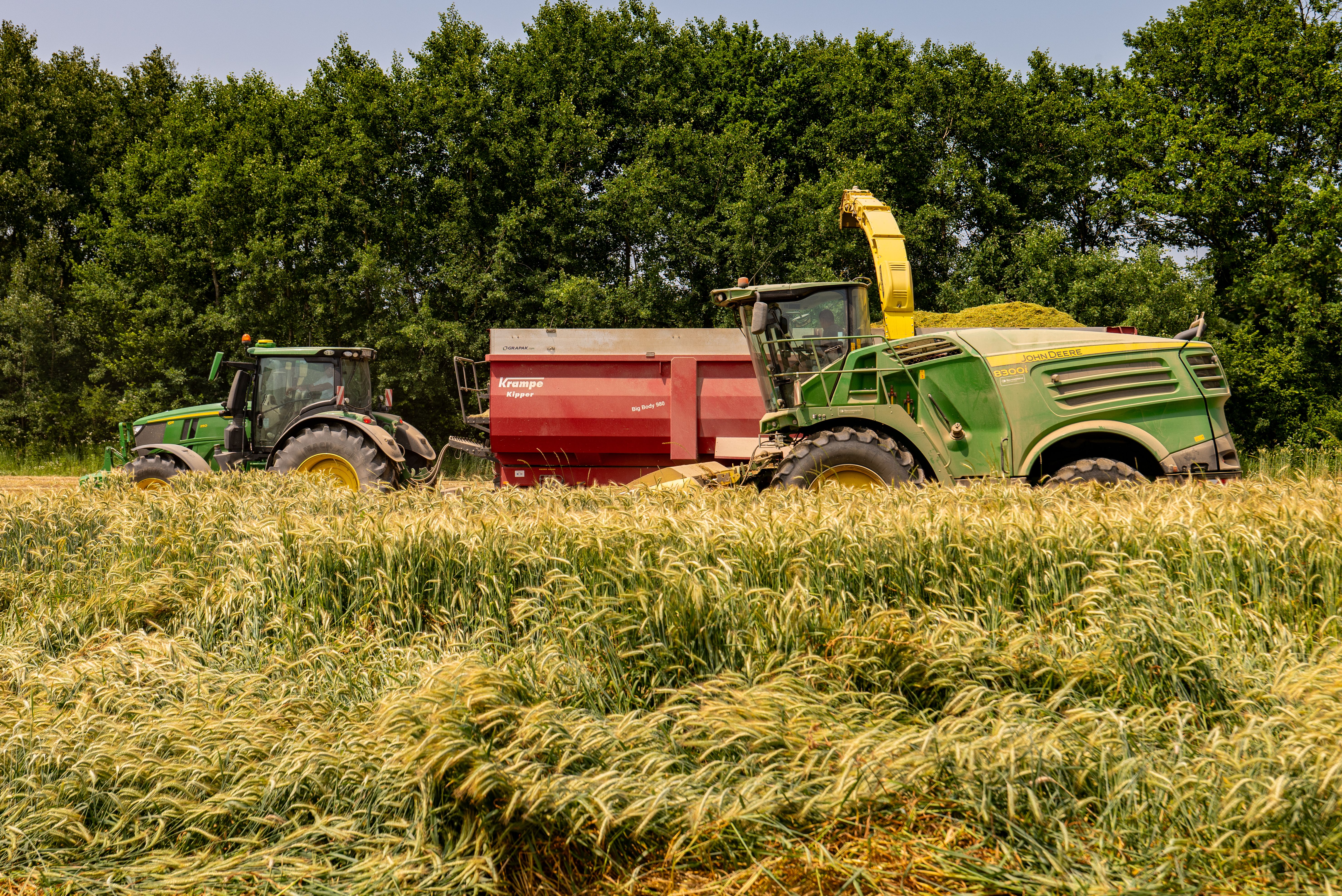 Harvesting Crops with Tractors in Croatian Field · Free Stock Photo