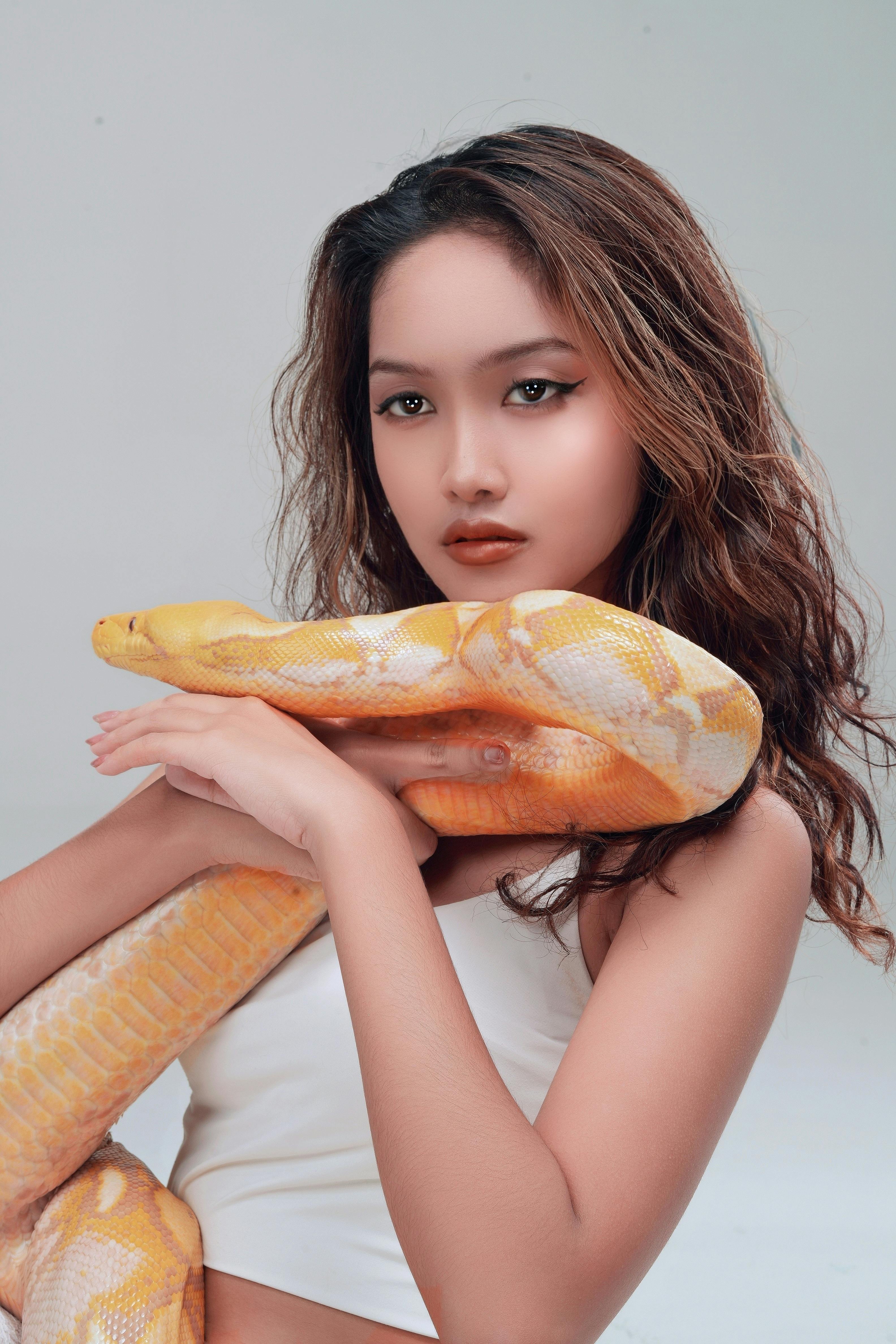 Portrait of a Woman with Yellow Python · Free Stock Photo