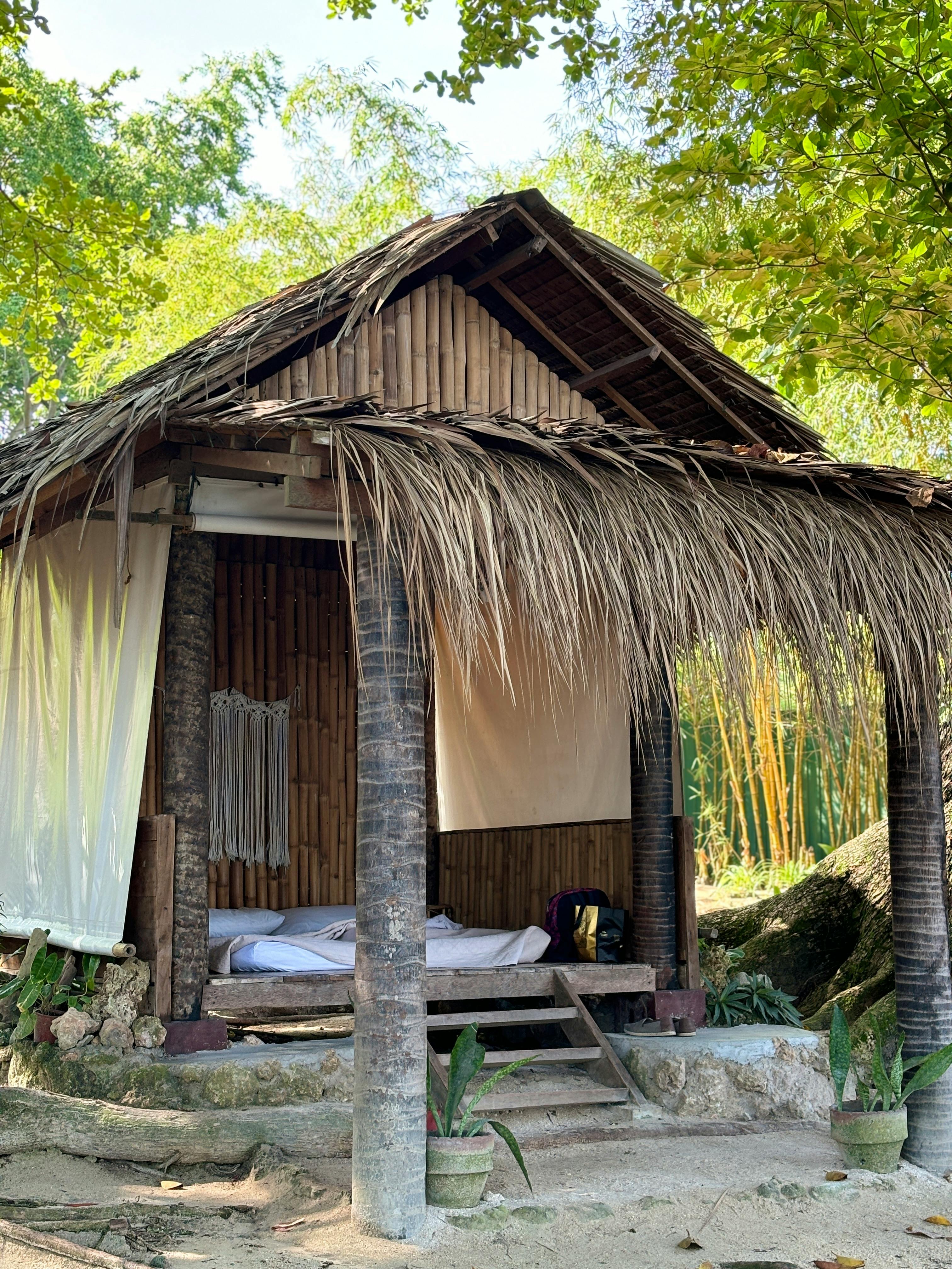 Tranquil Bamboo Hut Retreat in Tropical Setting · Free Stock Photo