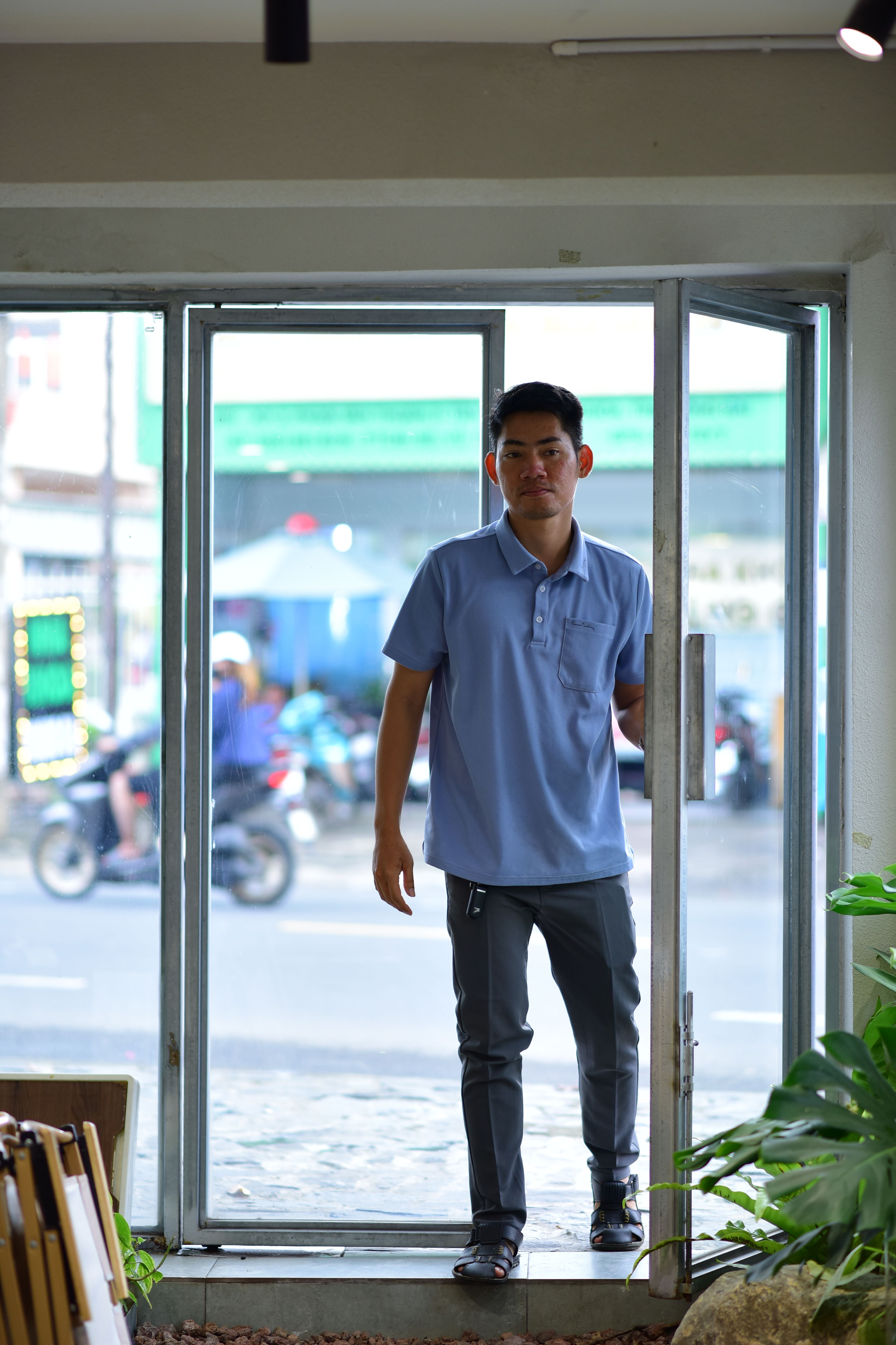 Man Entering a Modern Cafe on a Busy Street · Free Stock Photo