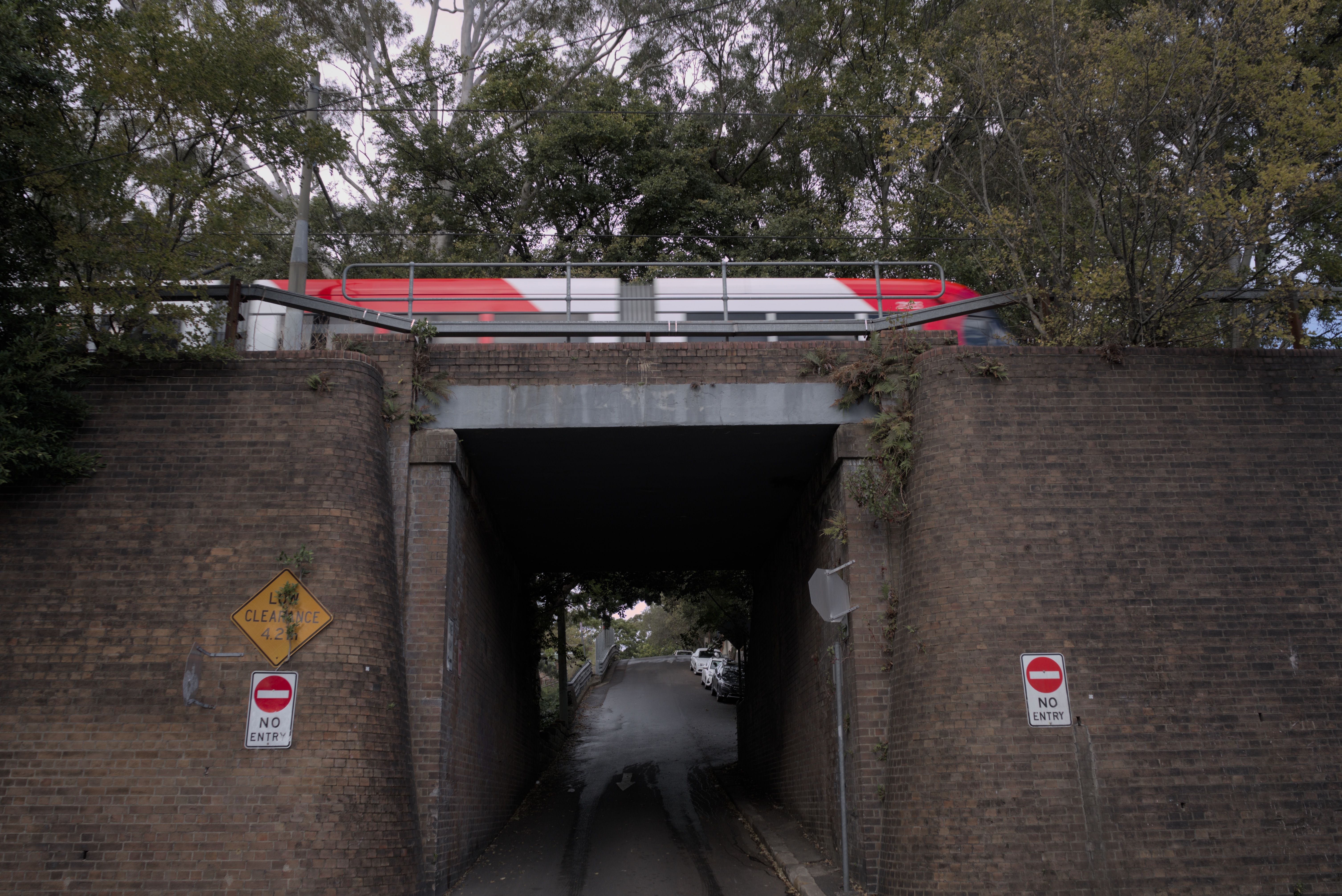 Train Passing Over Tunnel with No Entry Signs · Free Stock Photo