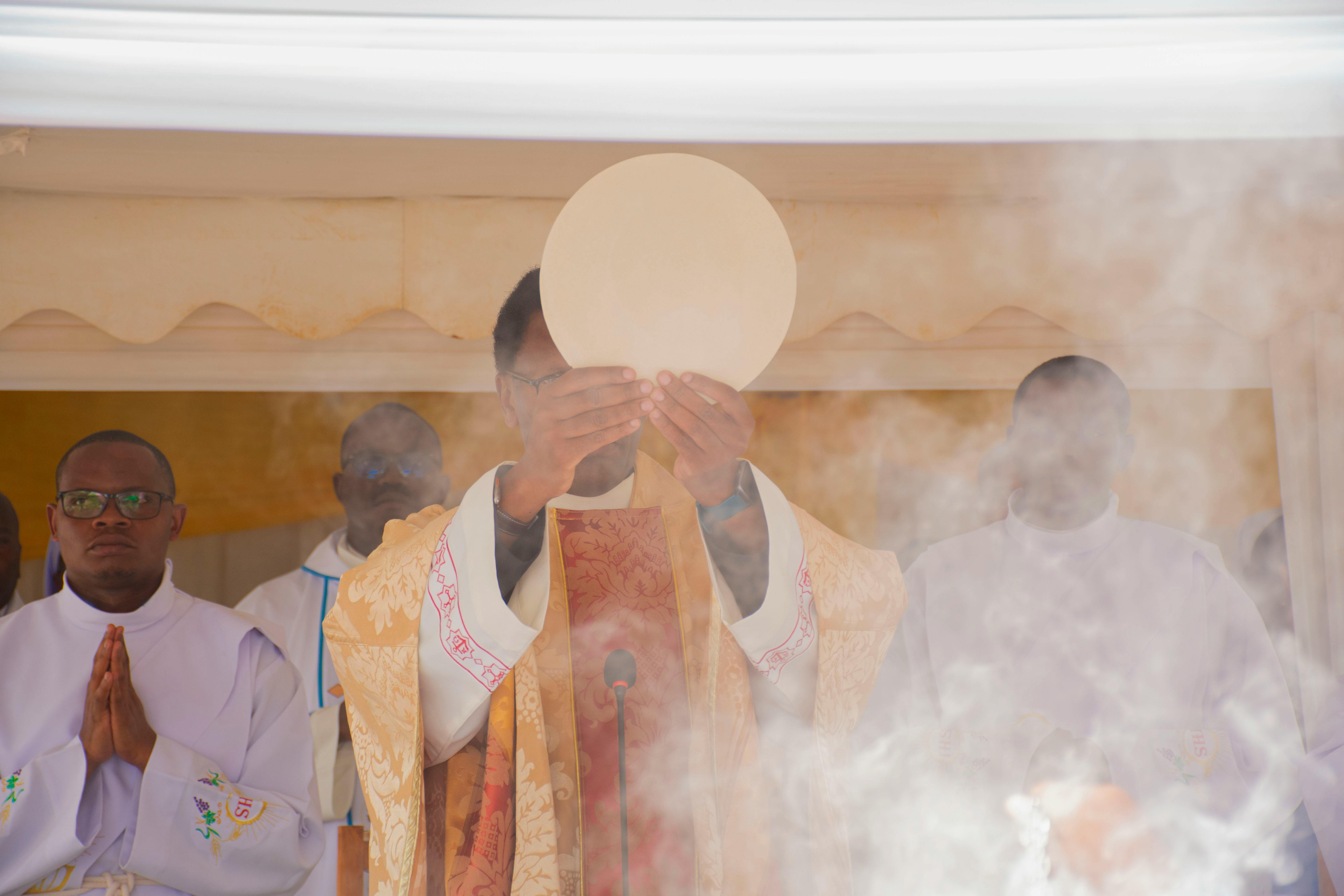 Priest Performing Eucharist Ceremony with Incense · Free Stock Photo