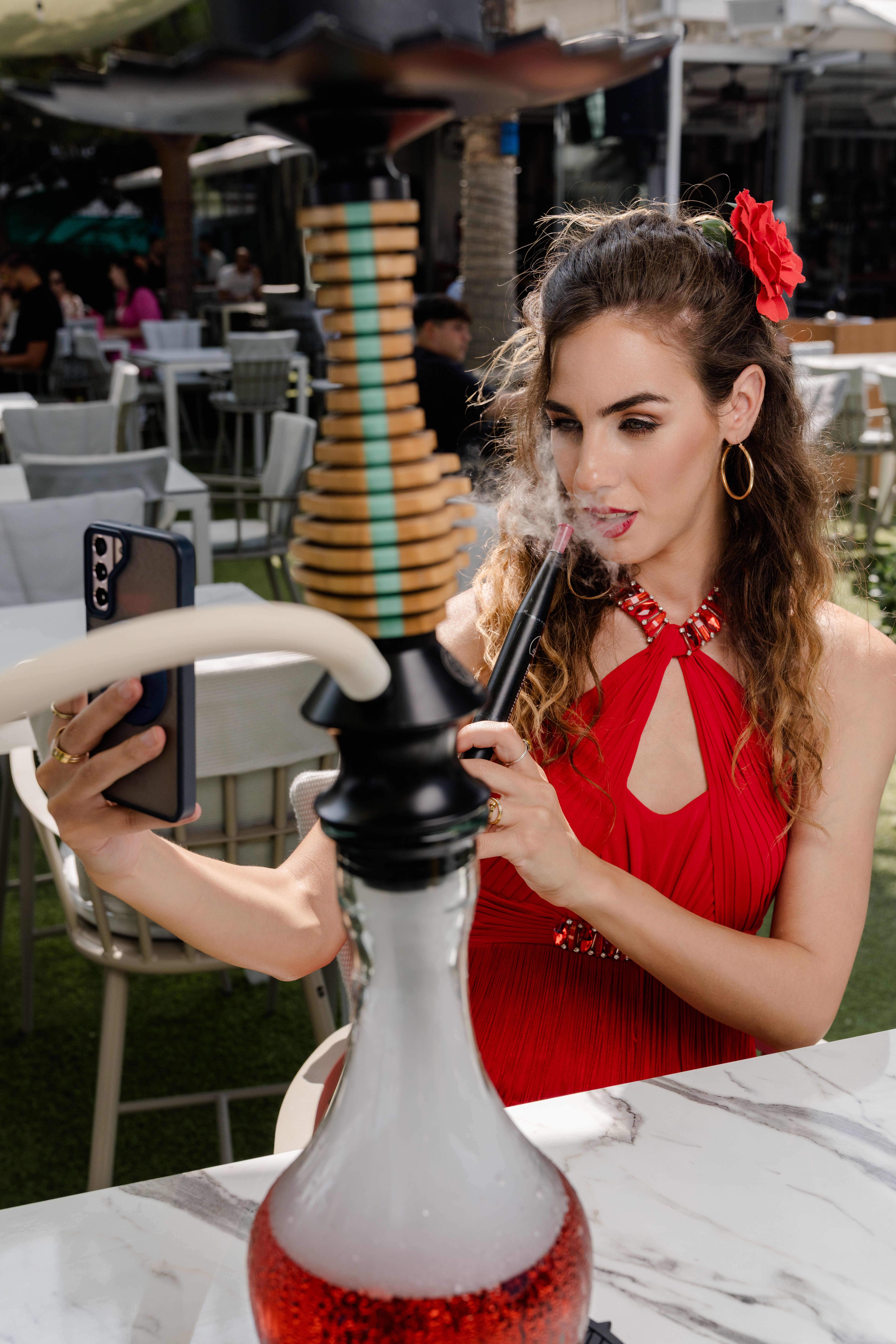 Woman Enjoying Hookah While Taking Selfie Outdoors · Free Stock Photo