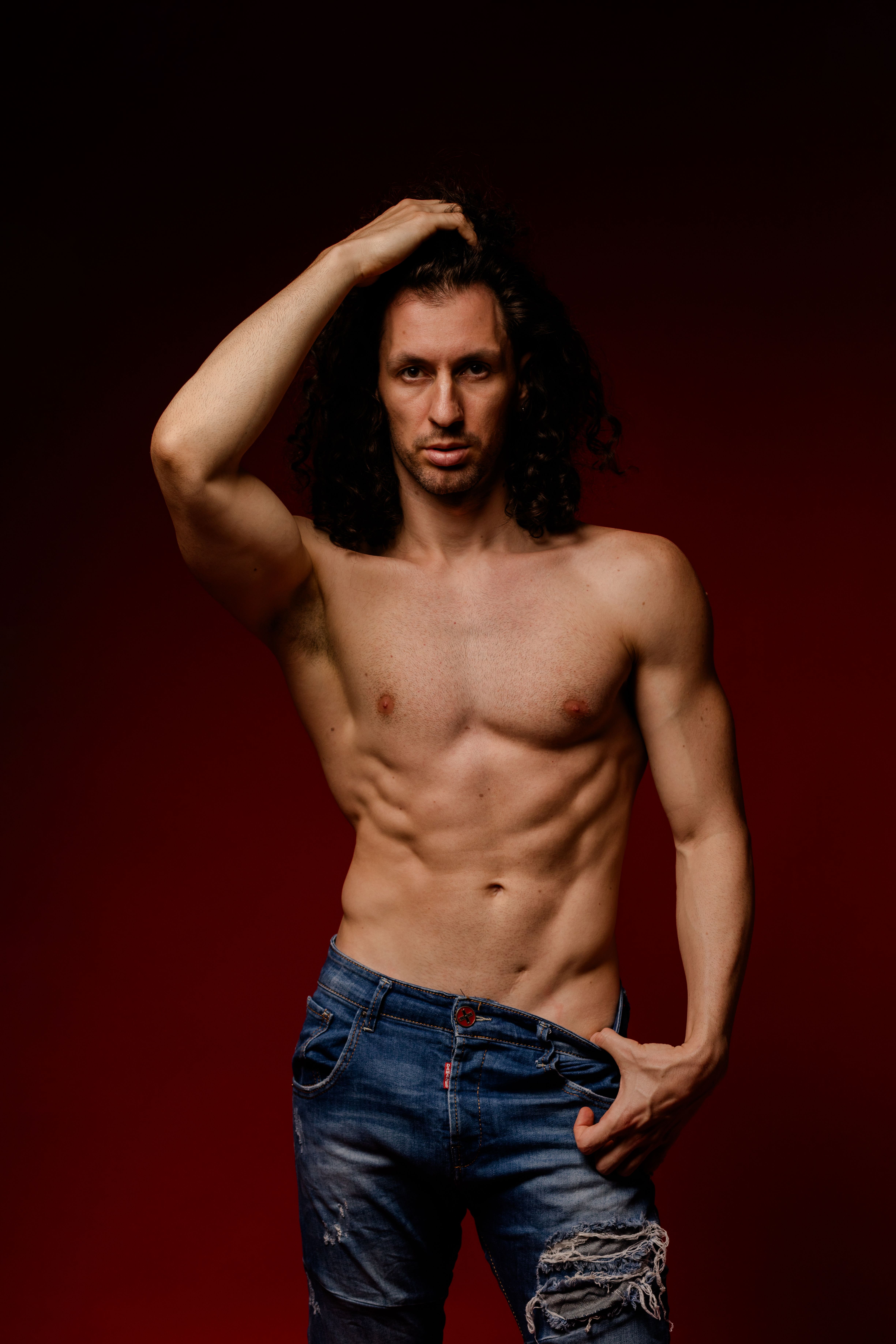 Fit Male Model in Jeans on Dark Background · Free Stock Photo