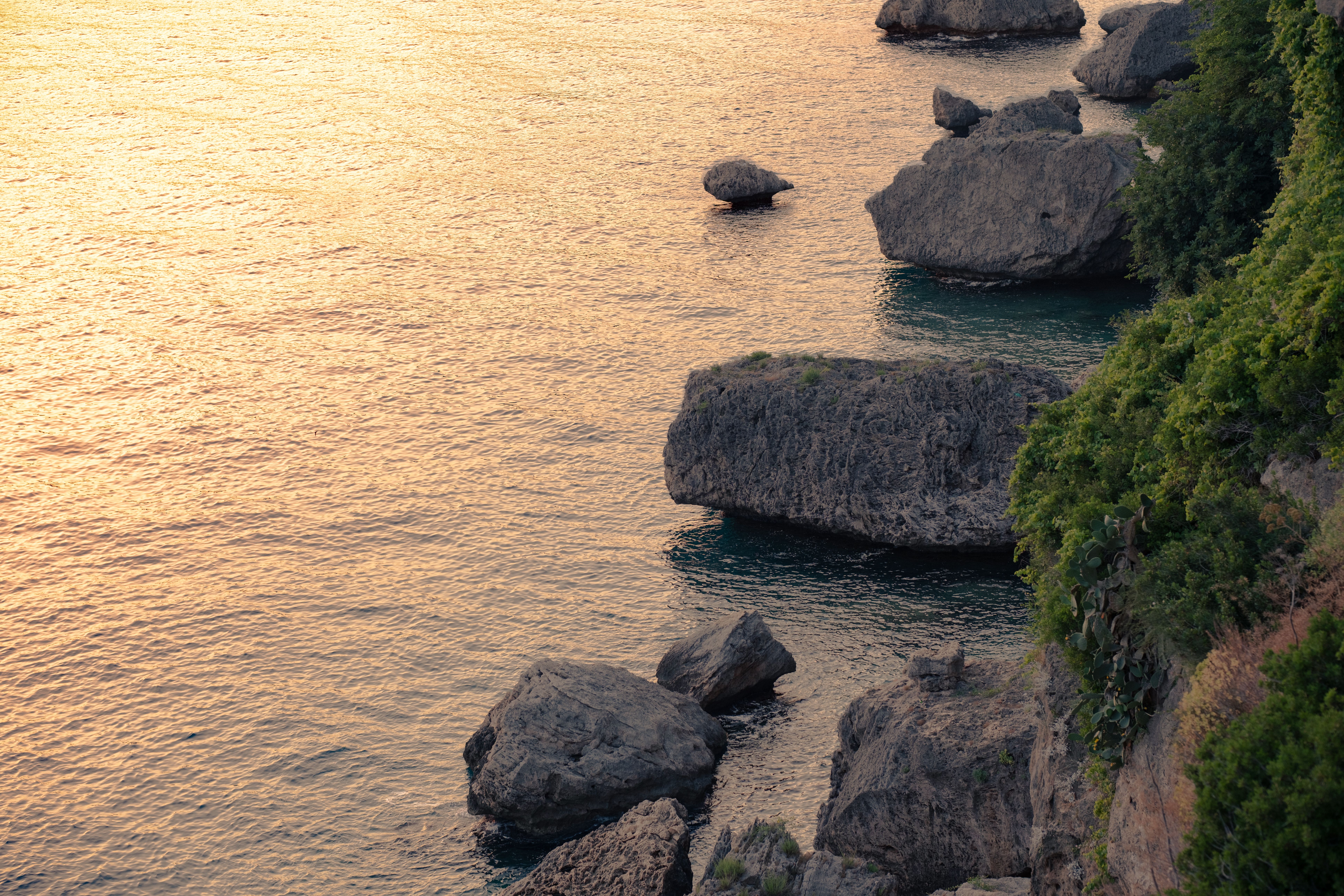 Golden Sunset Over Coastline with Rocky Cliffs · Free Stock Photo