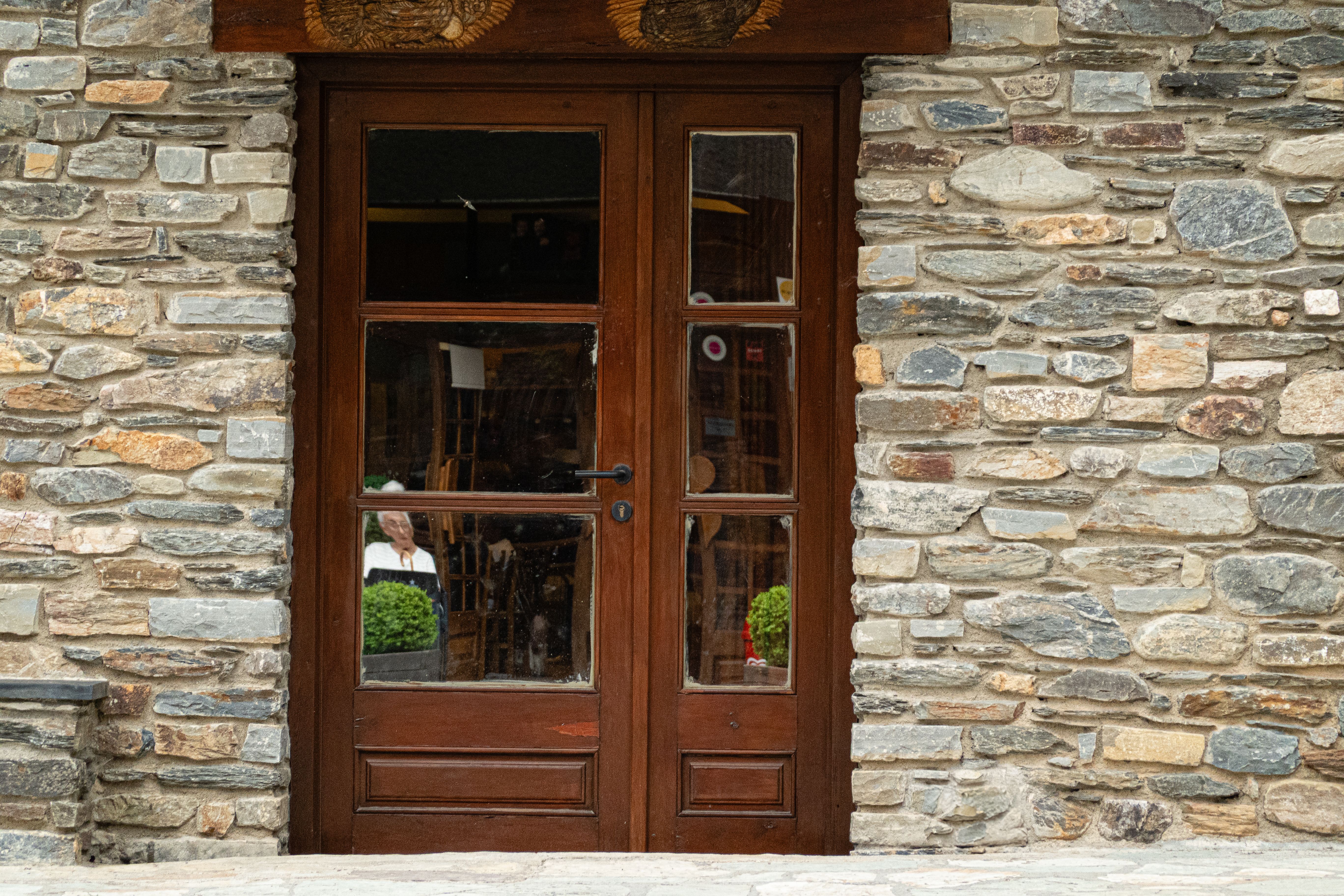 Rustic Wooden Door in Stone Wall Entrance · Free Stock Photo