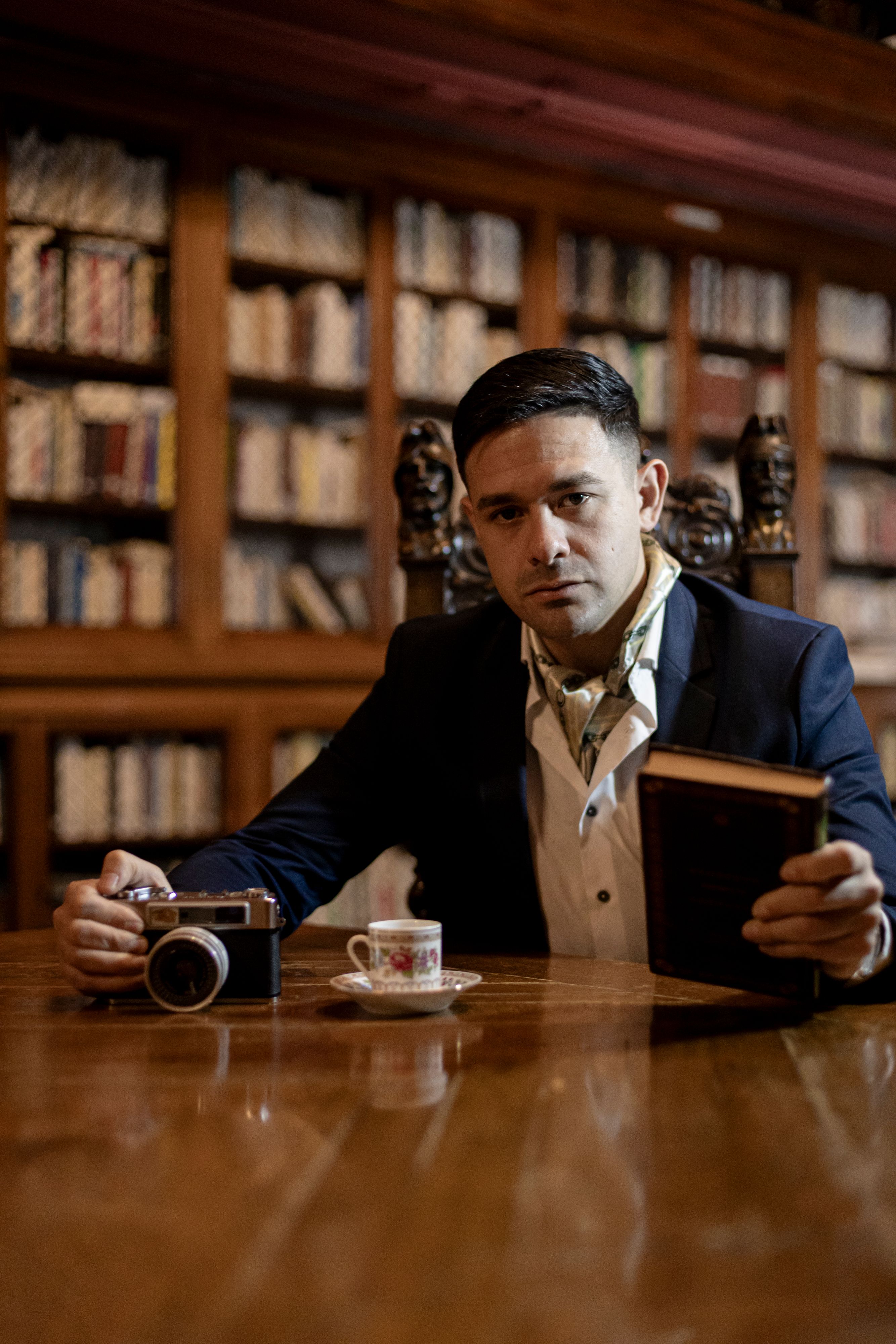 Elegant Portrait of Man in Library with Camera · Free Stock Photo