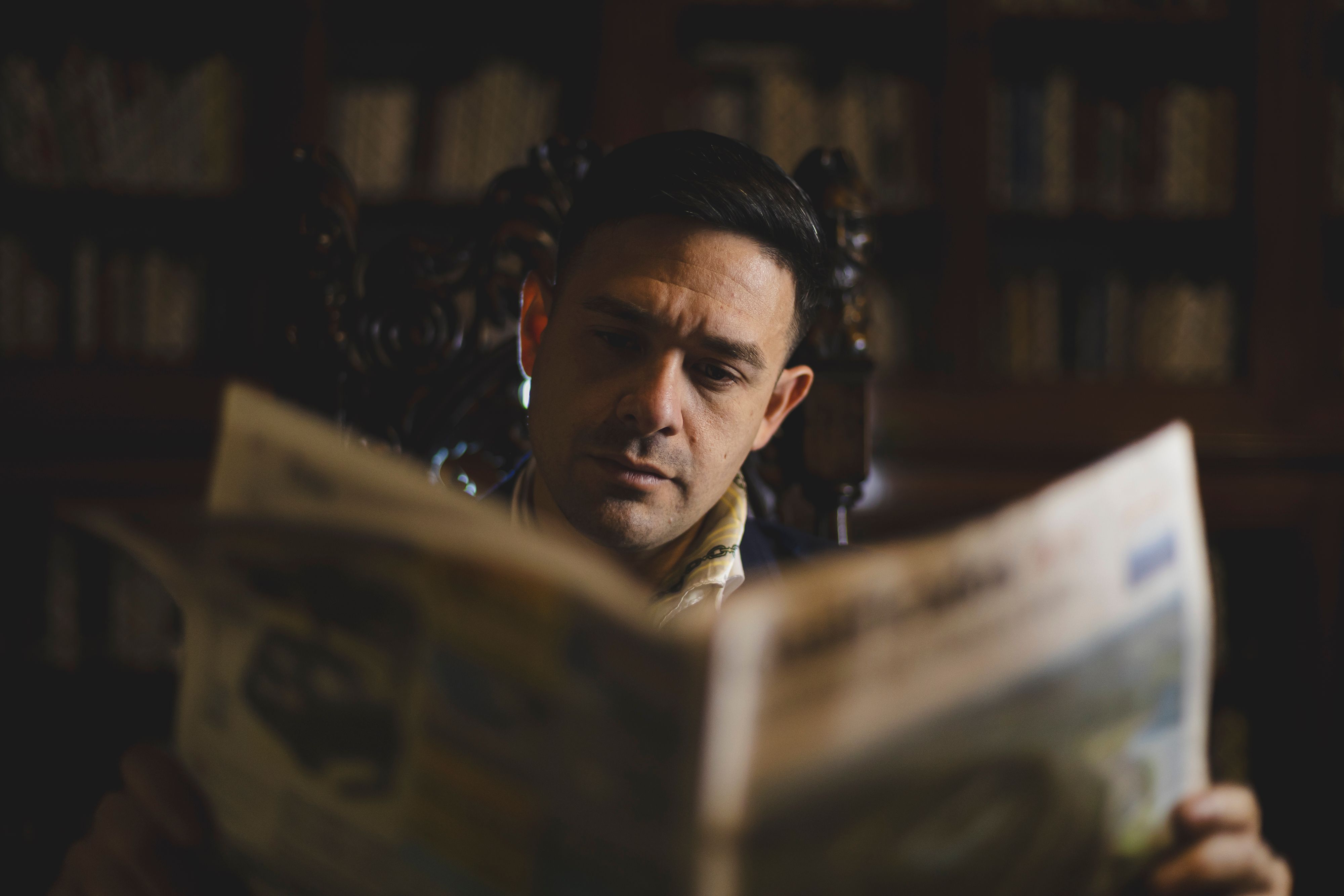 Man Reading Newspaper in Buenos Aires Library · Free Stock Photo