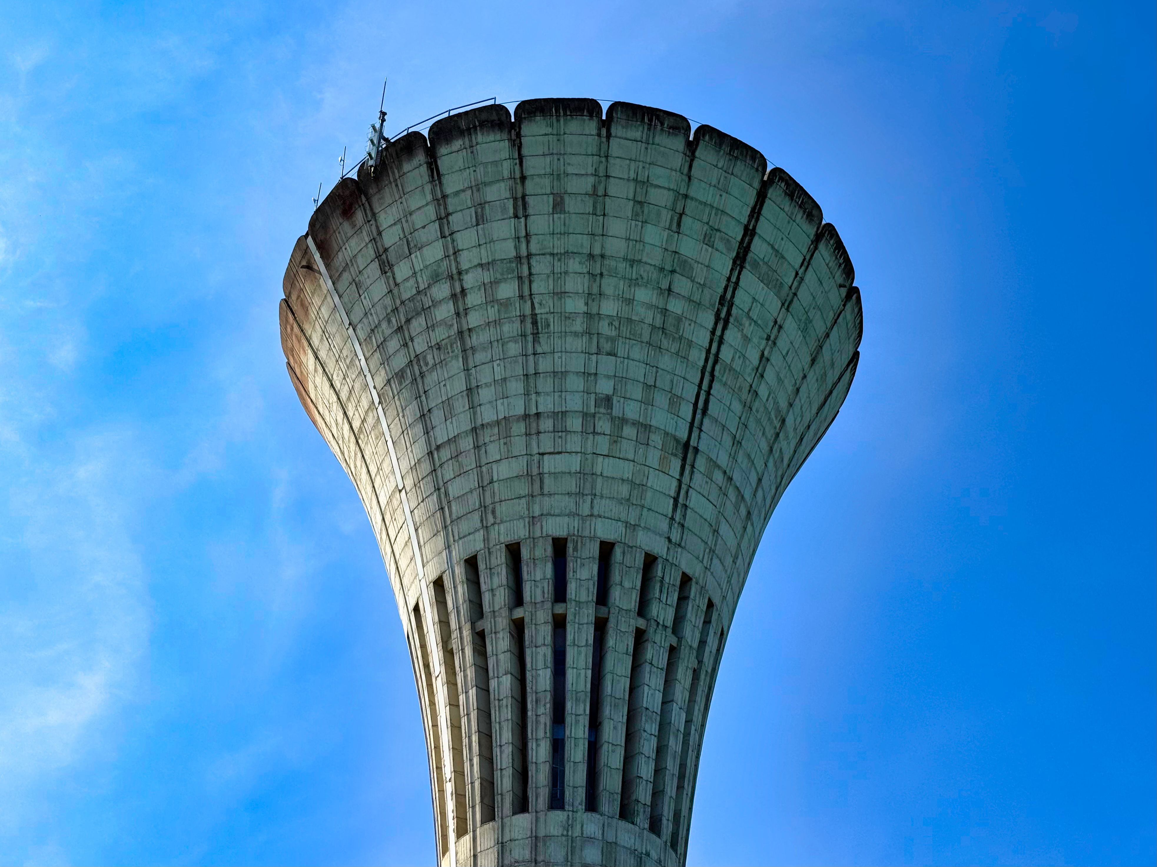 Concrete Water Tower Against Clear Blue Sky · Free Stock Photo