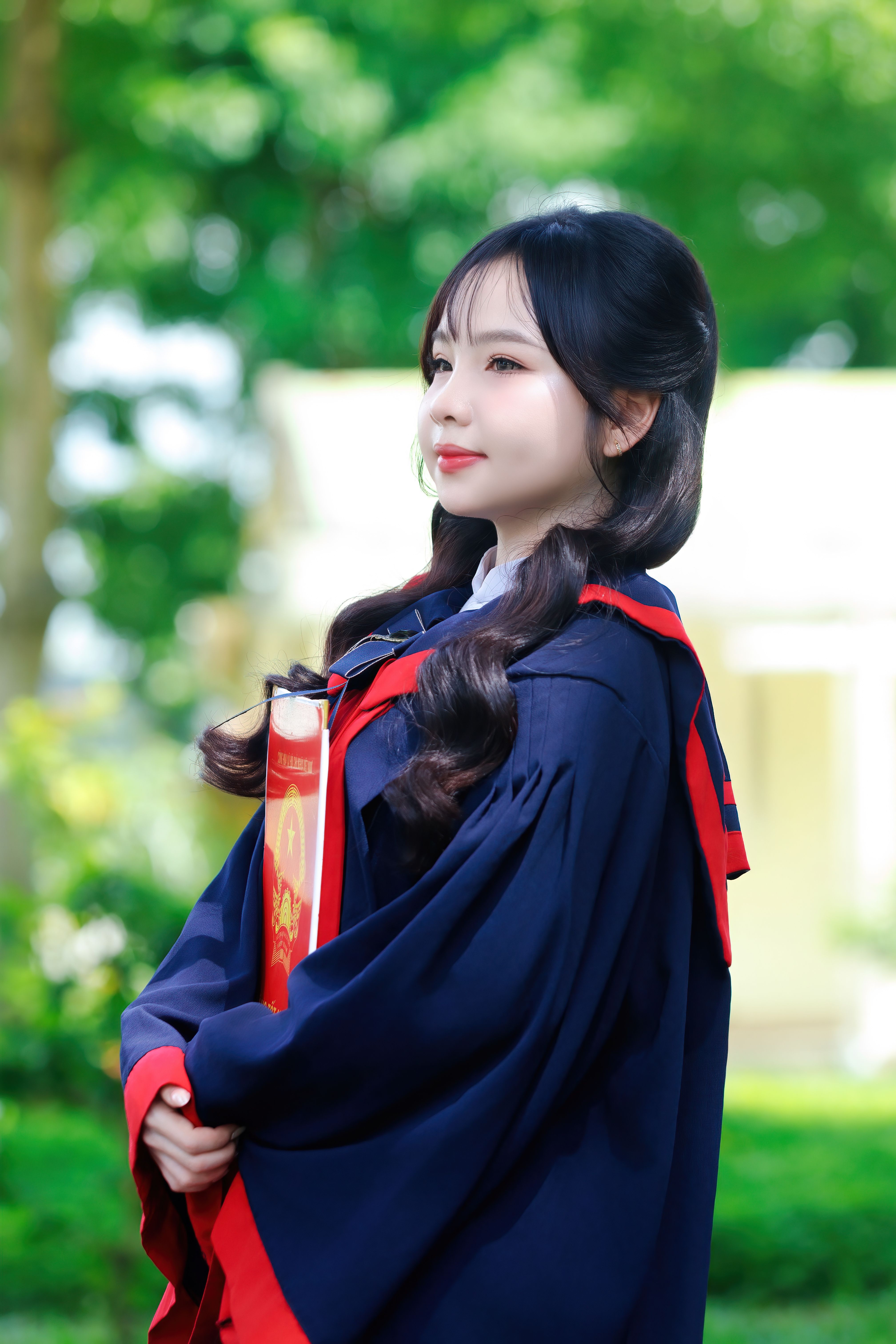 Elegant Graduate Celebrates Achievement Outdoors · Free Stock Photo