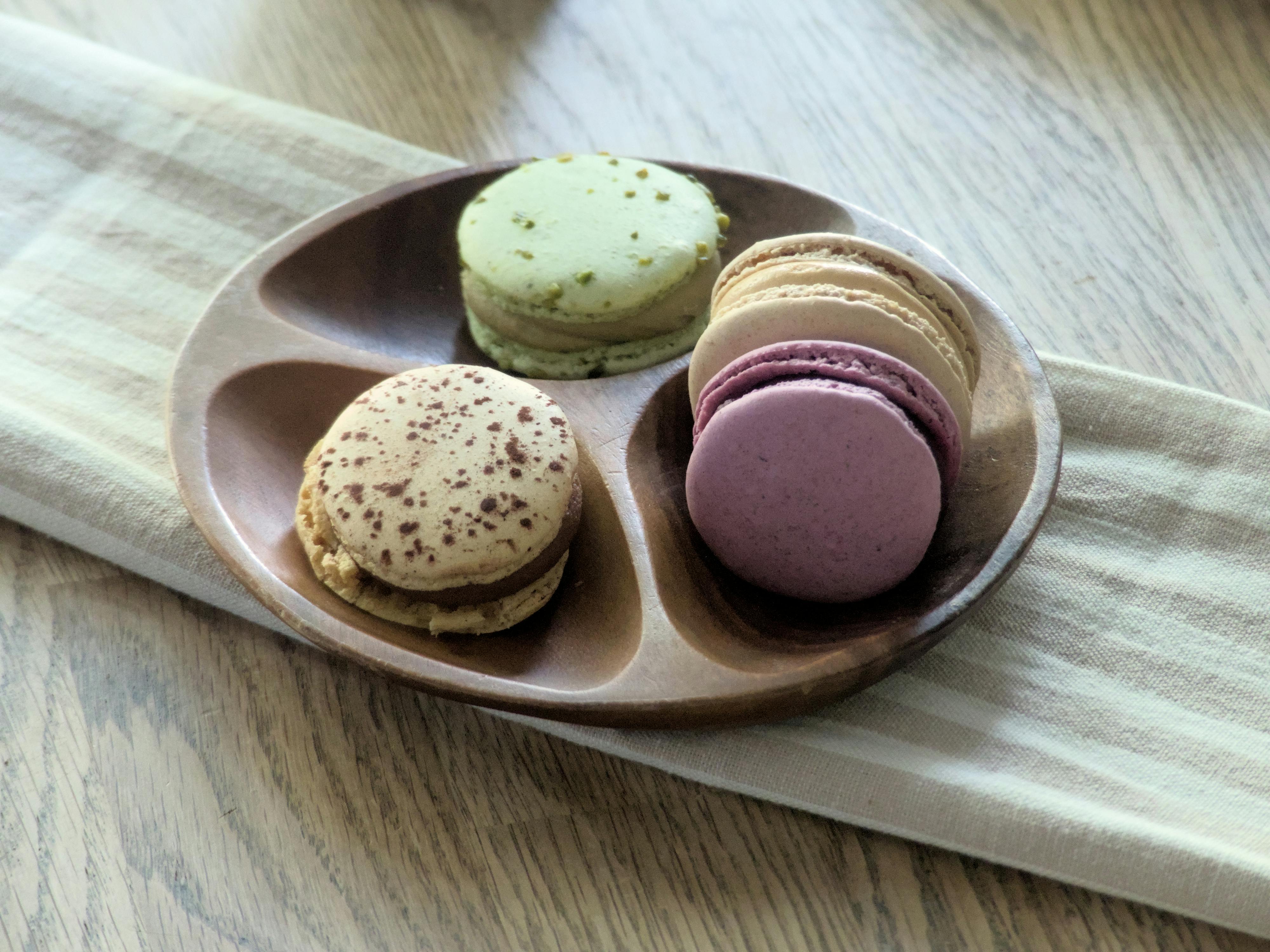 Colorful Assorted Macarons on Wooden Plate · Free Stock Photo
