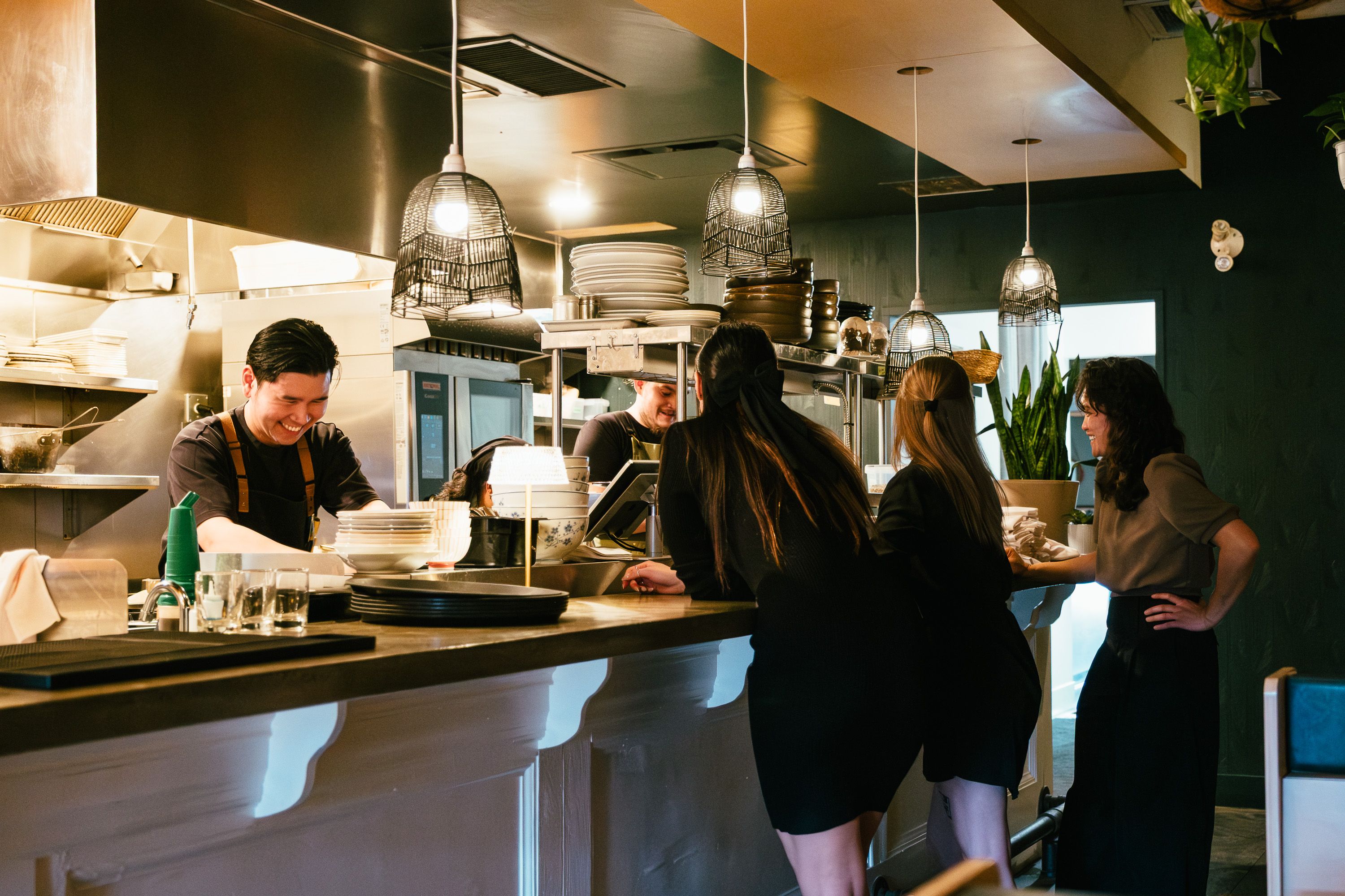 Cozy Restaurant Kitchen with Staff and Diners · Free Stock Photo