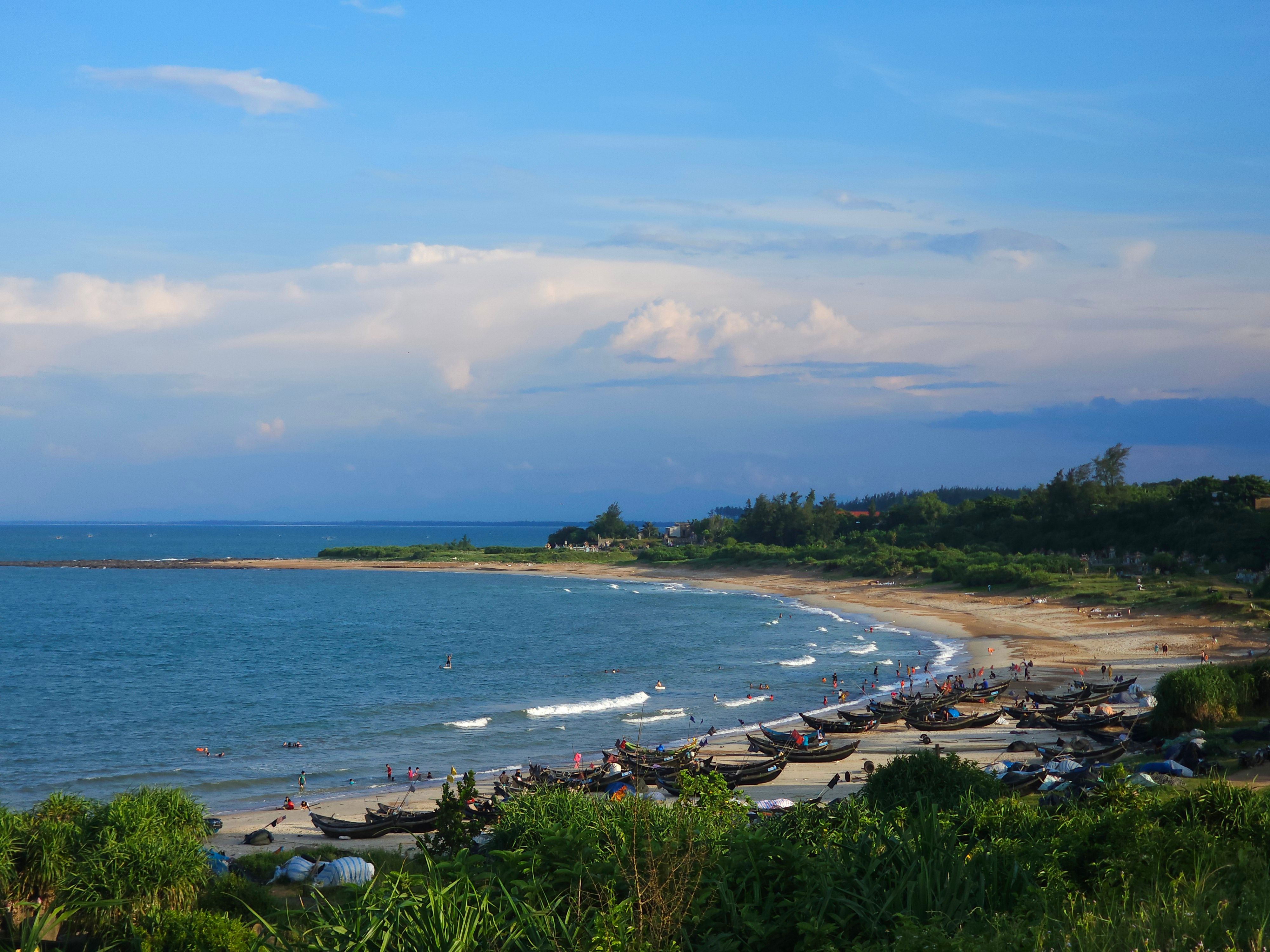 Scenic Beach View with Boats and Waves · Free Stock Photo