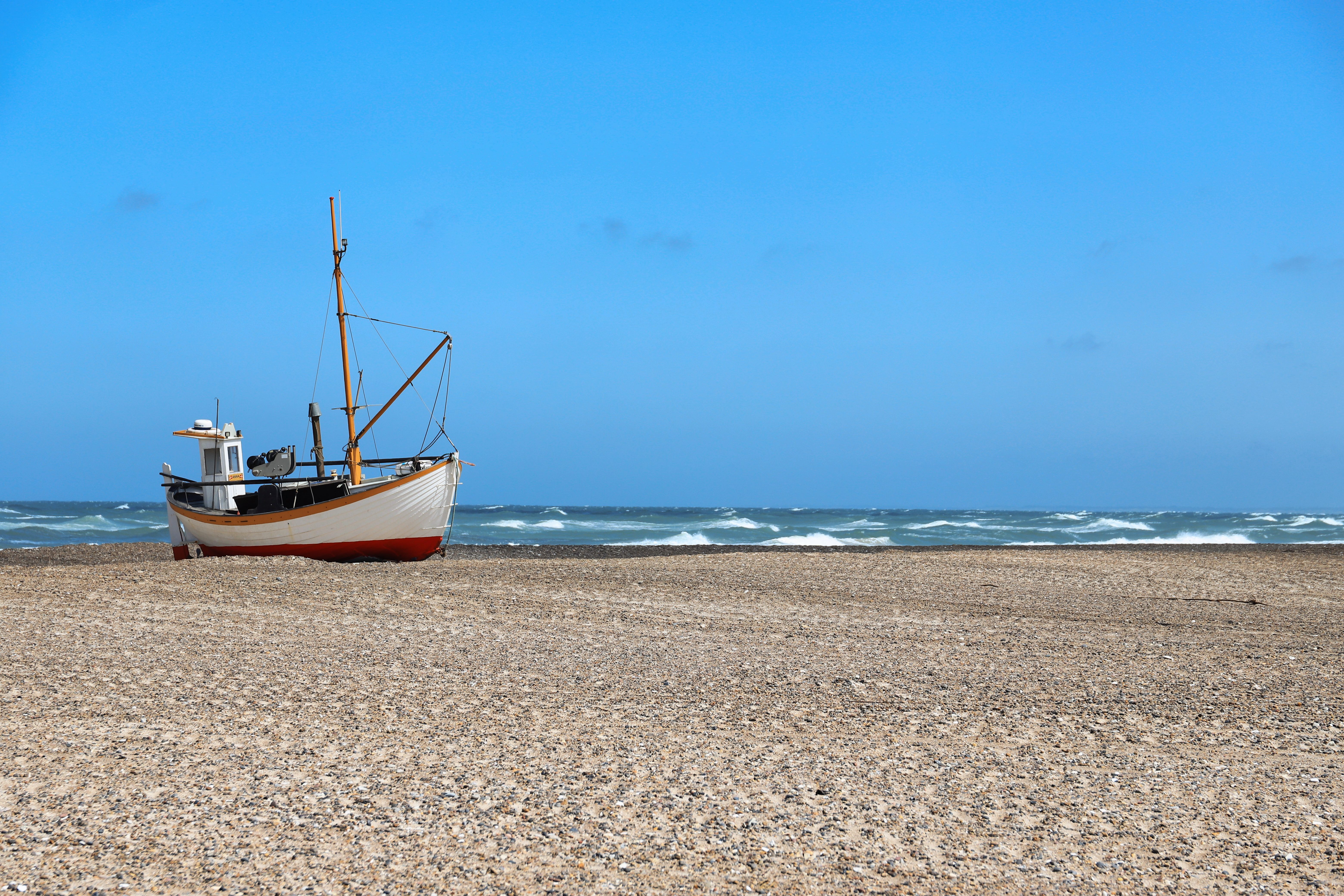 Picturesque Beach with Wooden Boat in Denmark · Free Stock Photo