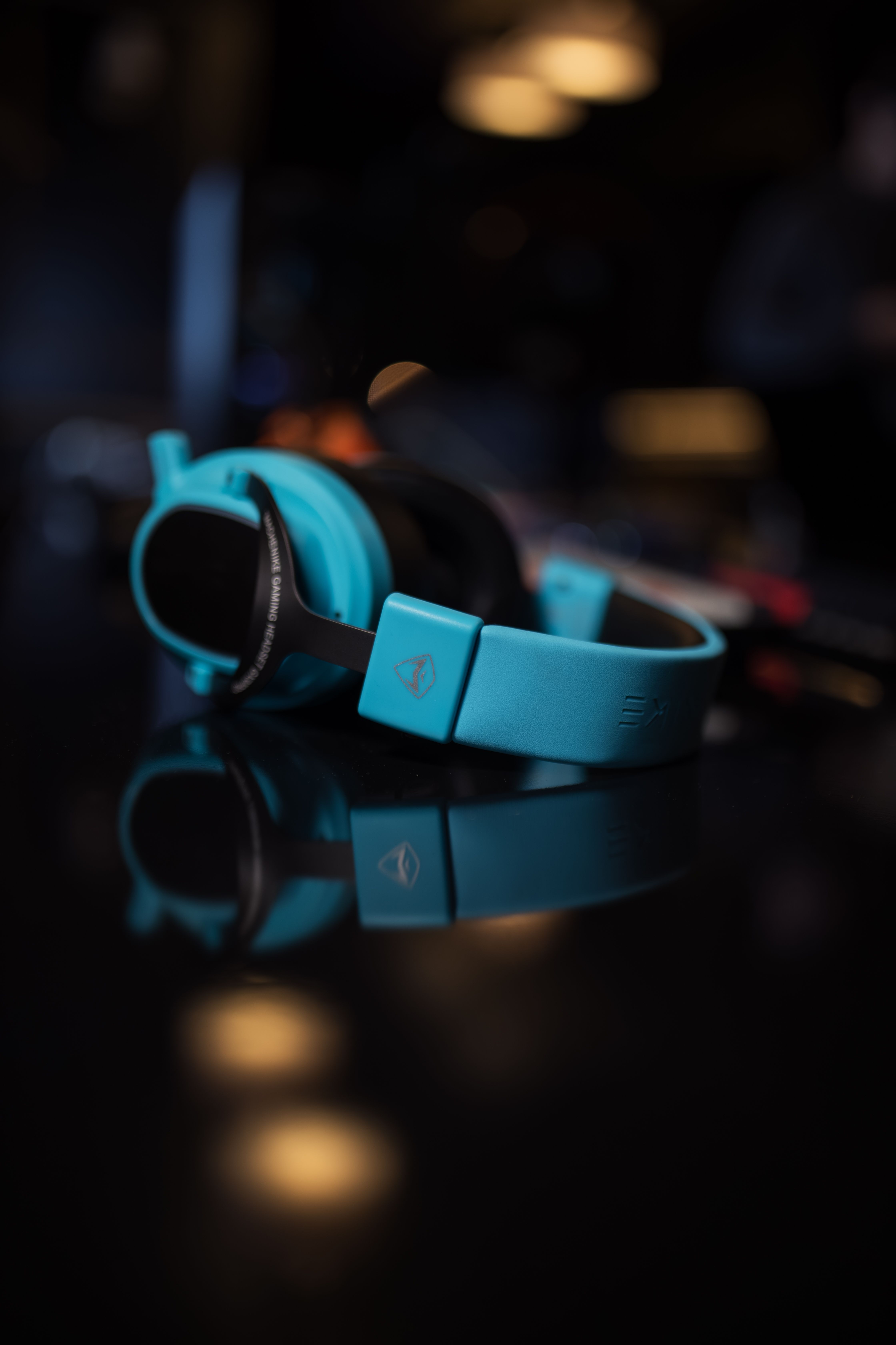 Vibrant Blue Headphones on Reflective Surface · Free Stock Photo