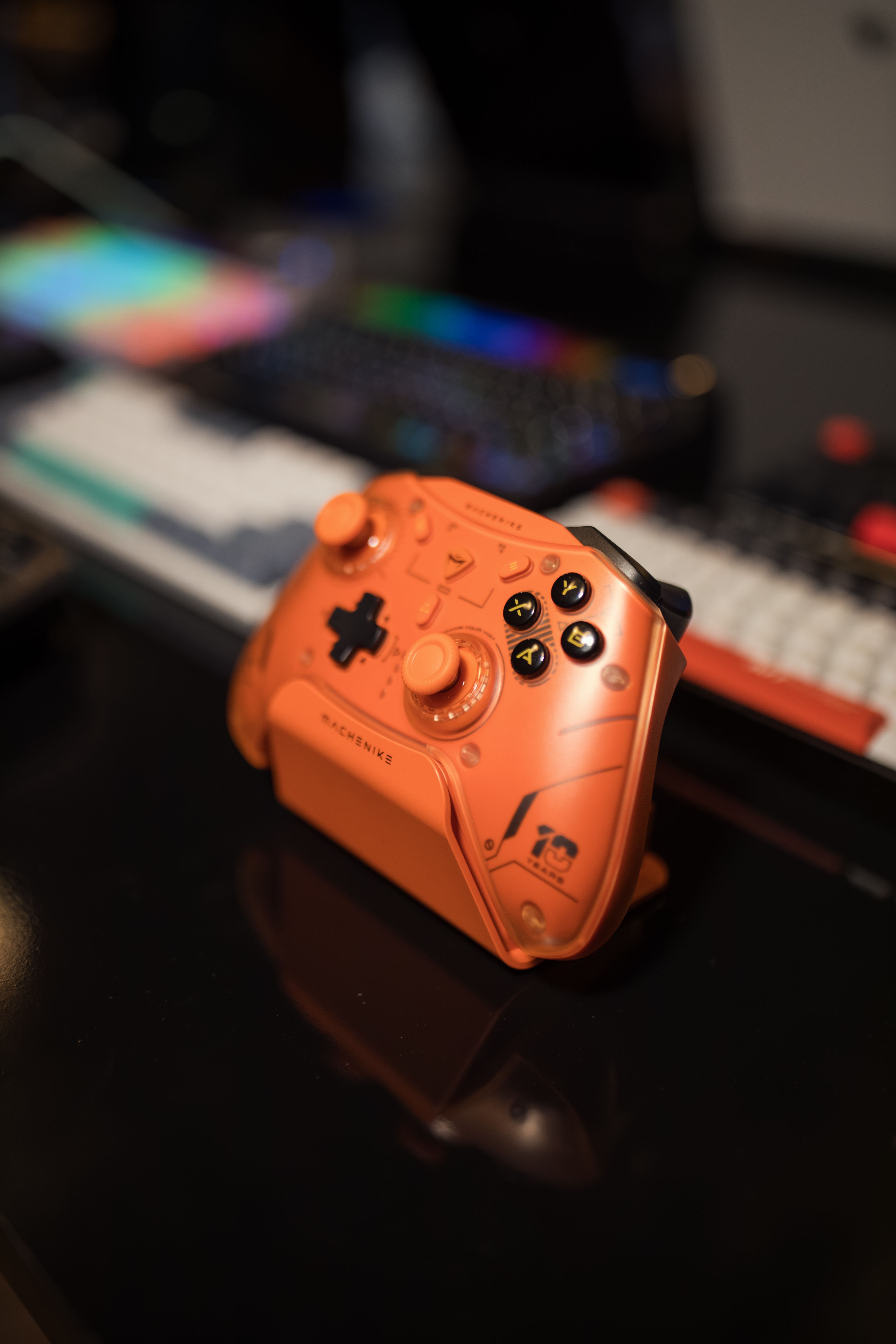 Orange Gaming Controller on Reflective Surface · Free Stock Photo