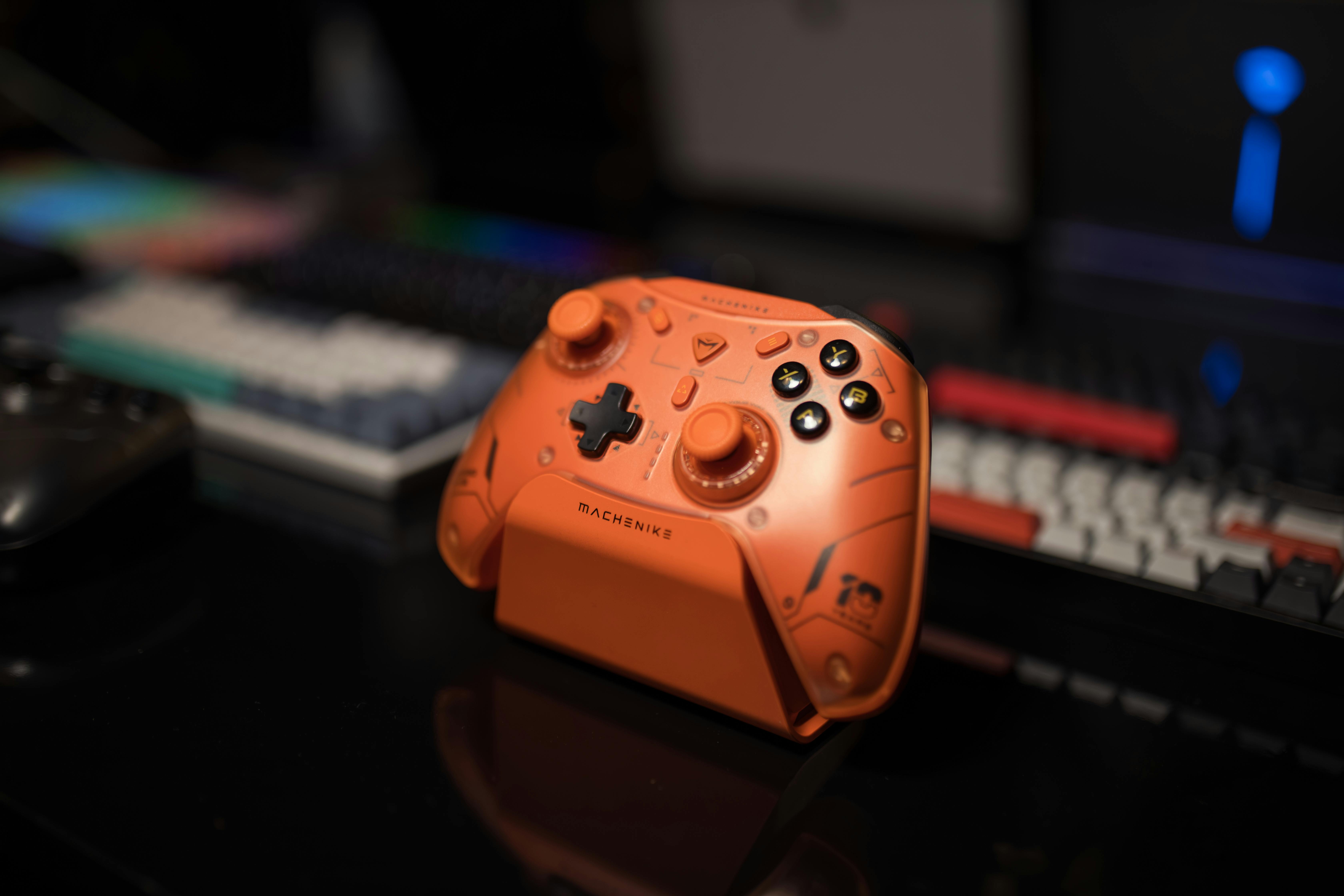 Bright Orange Gaming Controller on Desk · Free Stock Photo