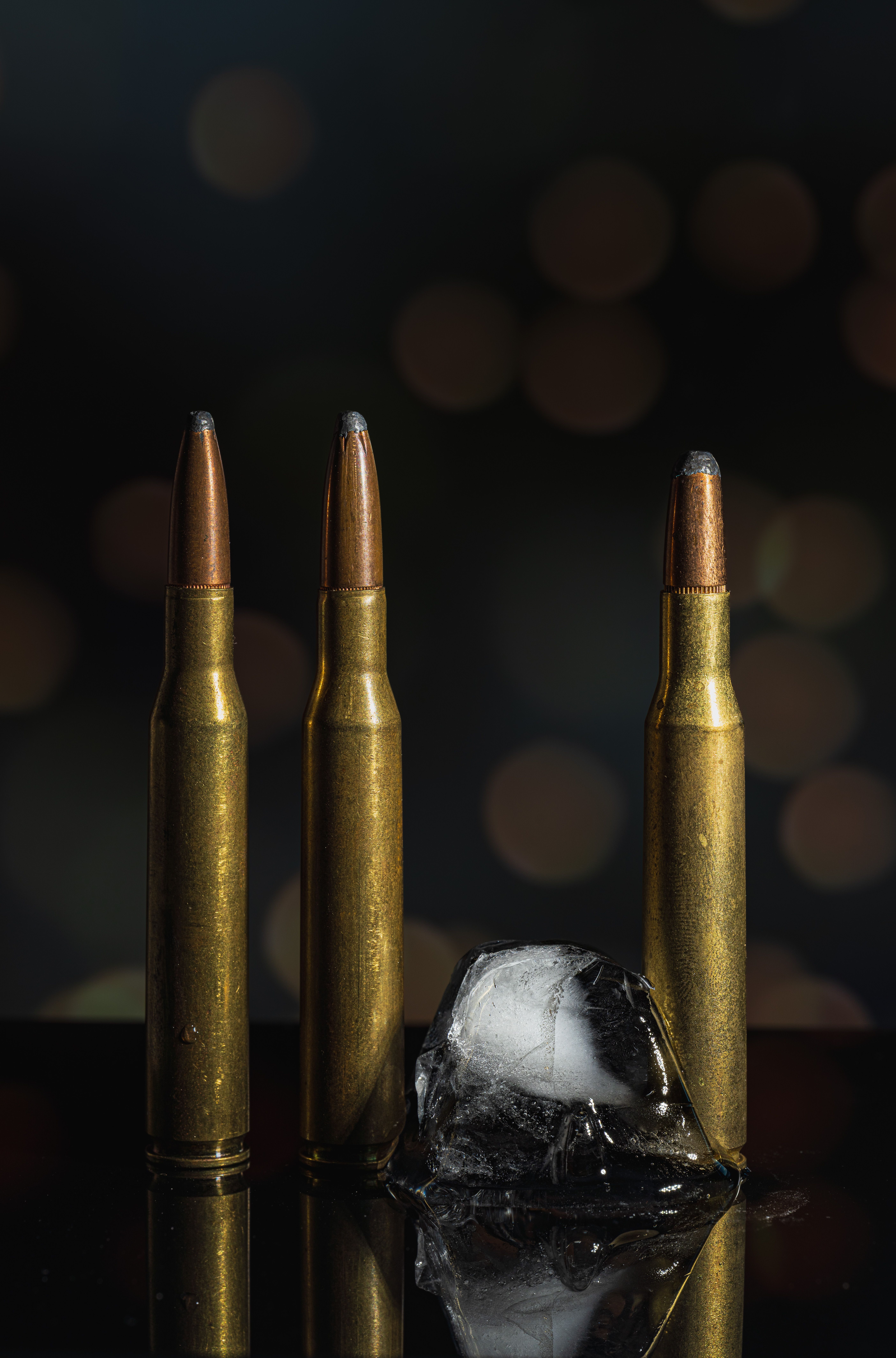 Bullet Still Life with Ice and Bokeh Background · Free Stock Photo