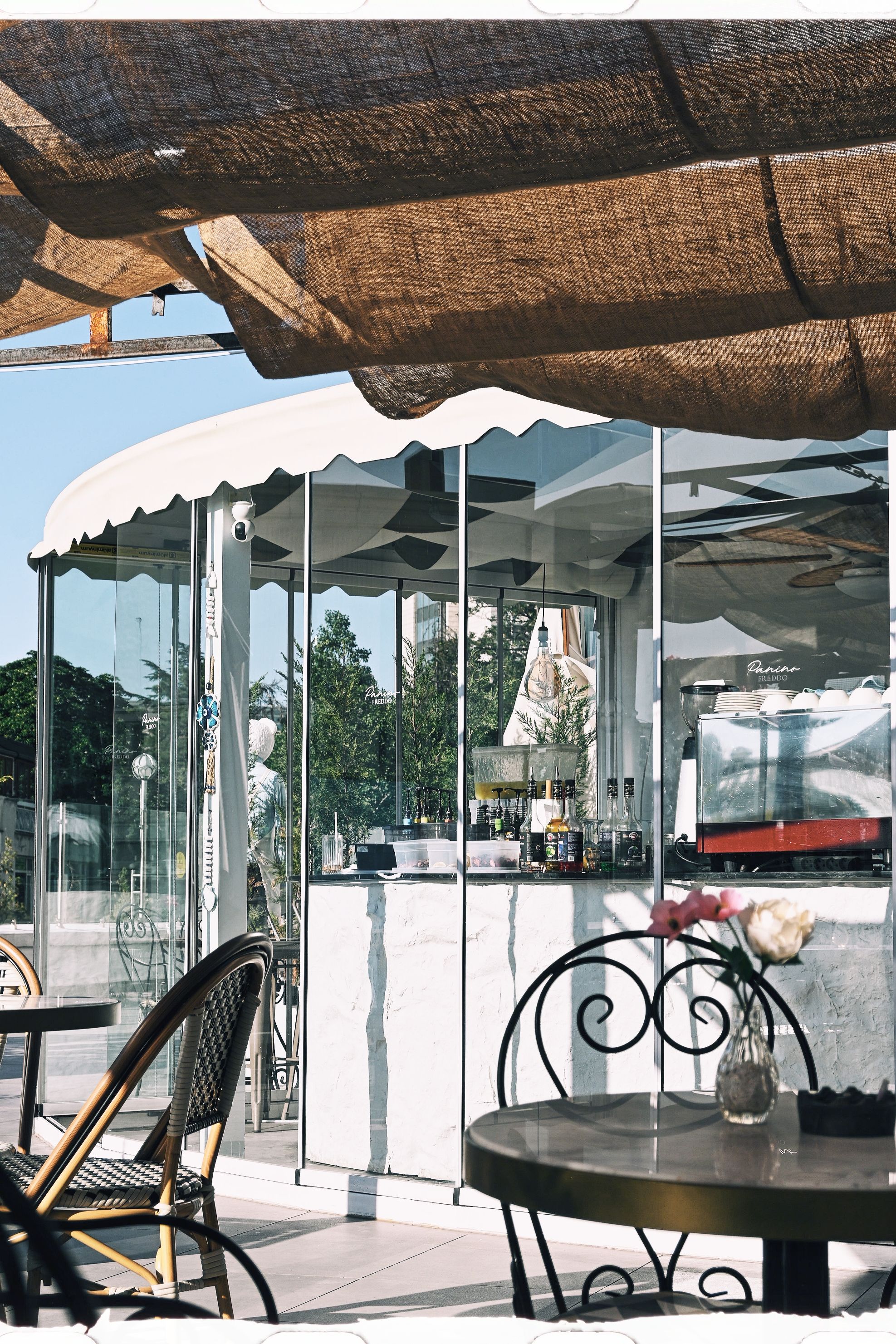Charming Outdoor Cafe with Glass Walls · Free Stock Photo