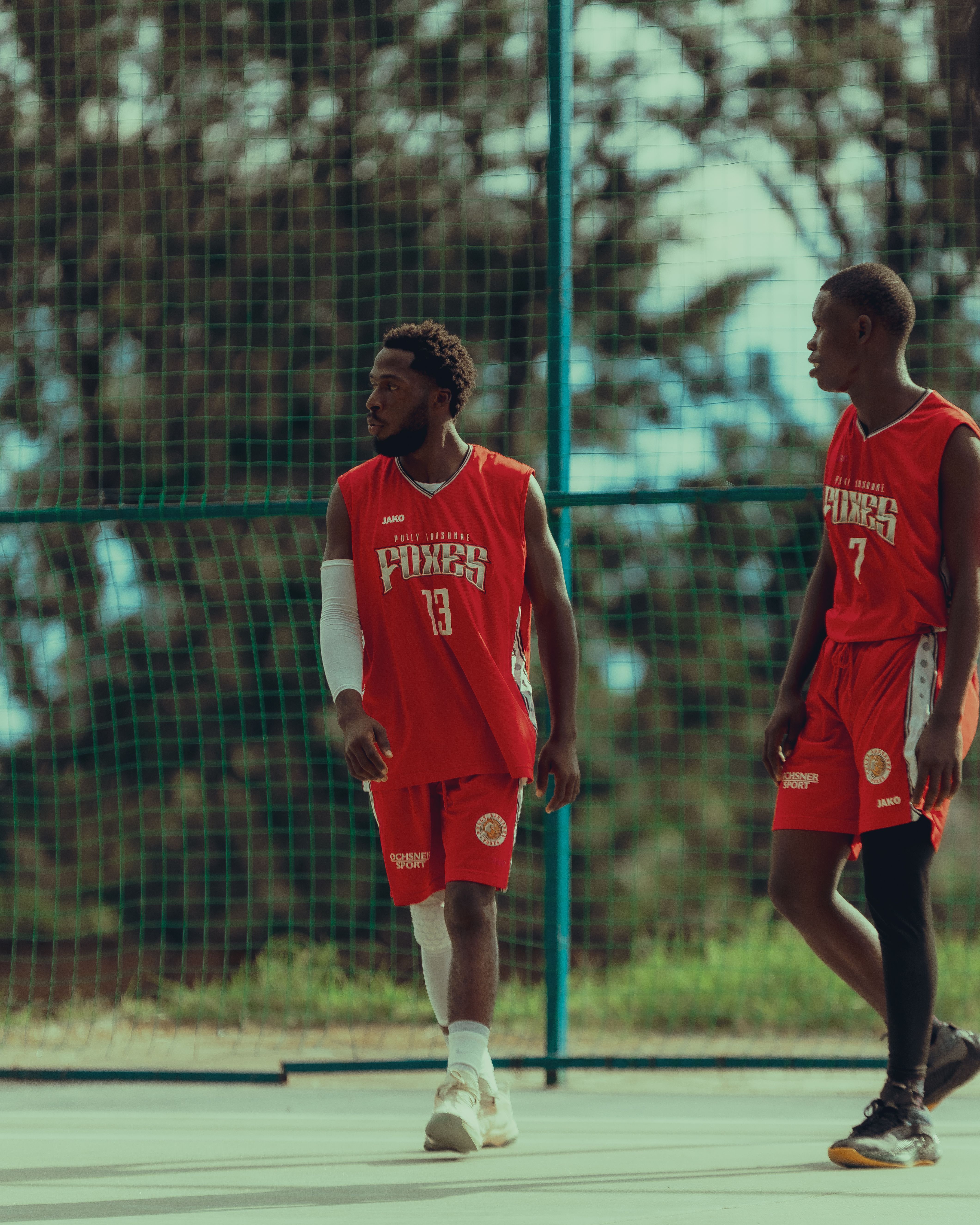 Two Basketball Players in Team Uniforms Outdoors · Free Stock Photo
