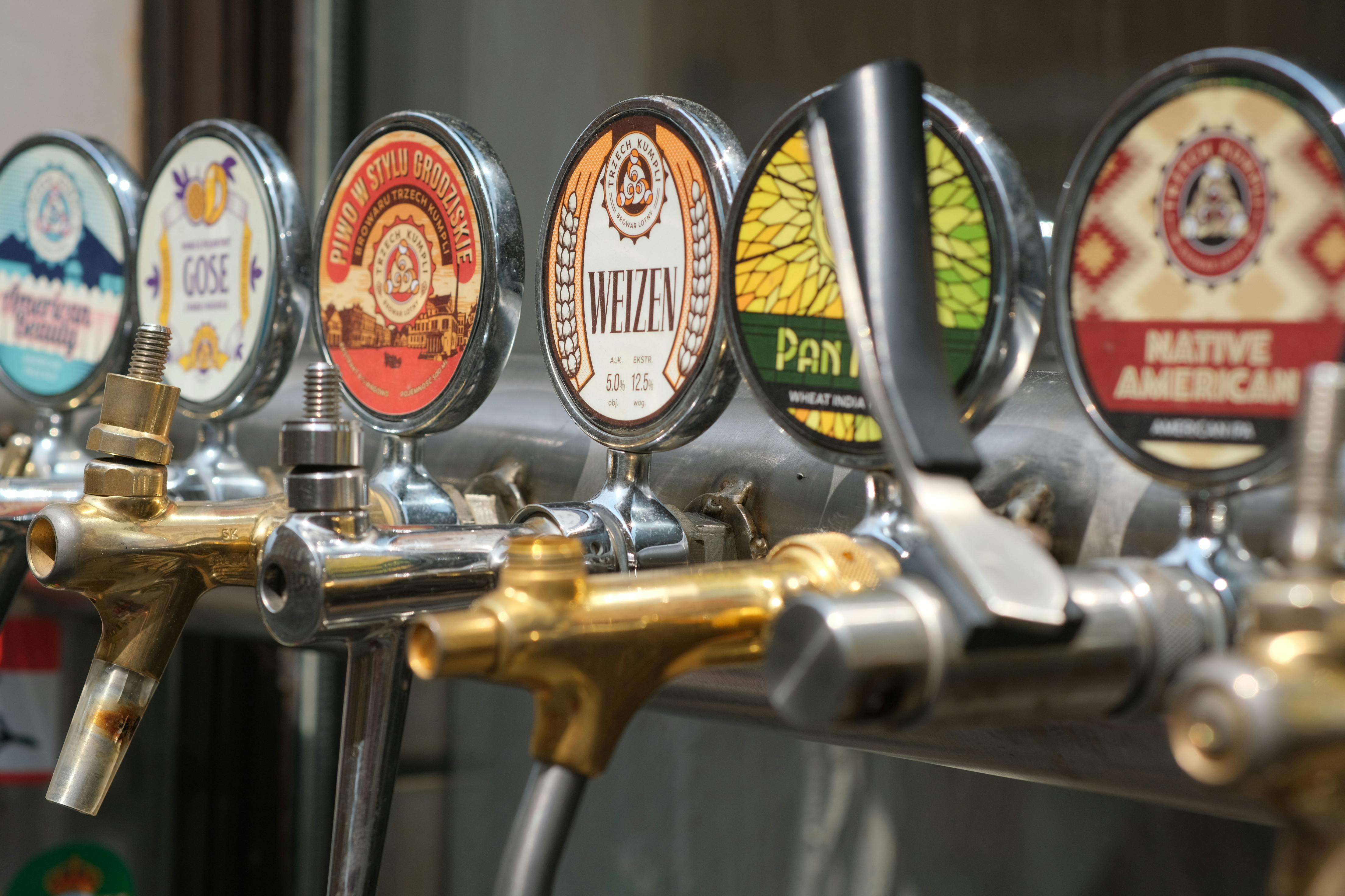 Craft Beer Taps with Various Brewery Labels · Free Stock Photo
