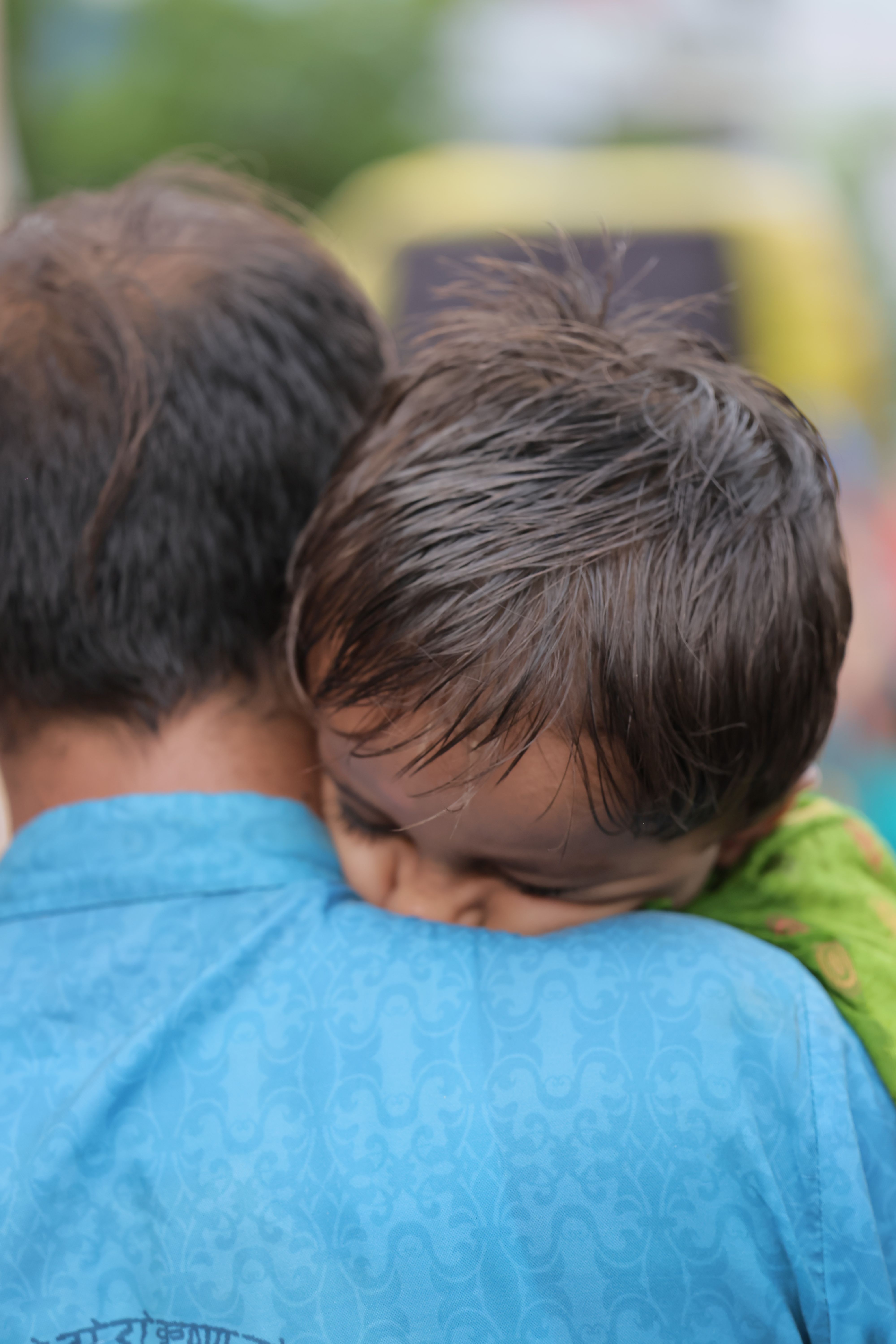 Father Holding Sleepy Child at Festival · Free Stock Photo