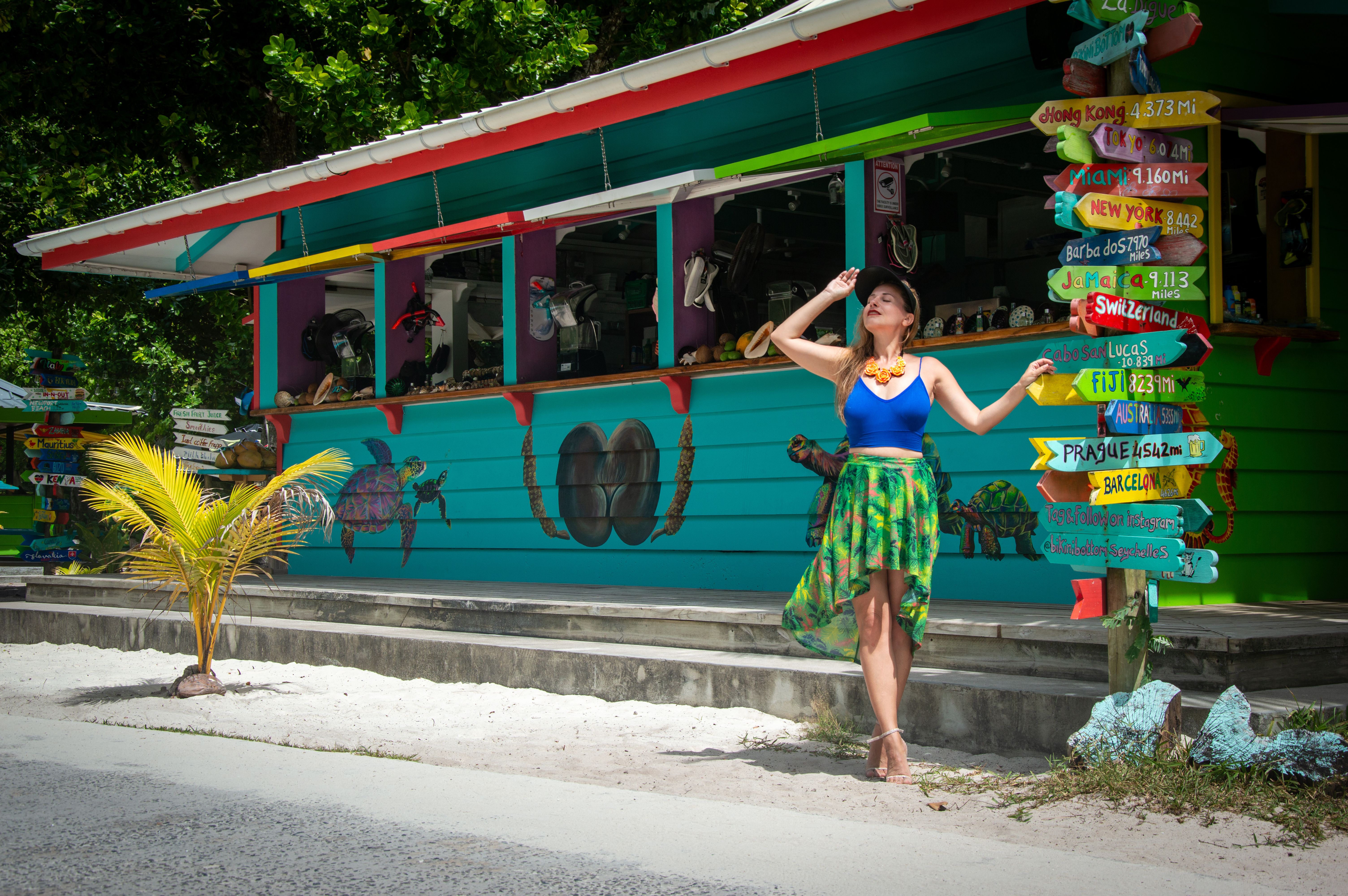Colorful Caribbean Beach Bar with Direction Signs · Free Stock Photo