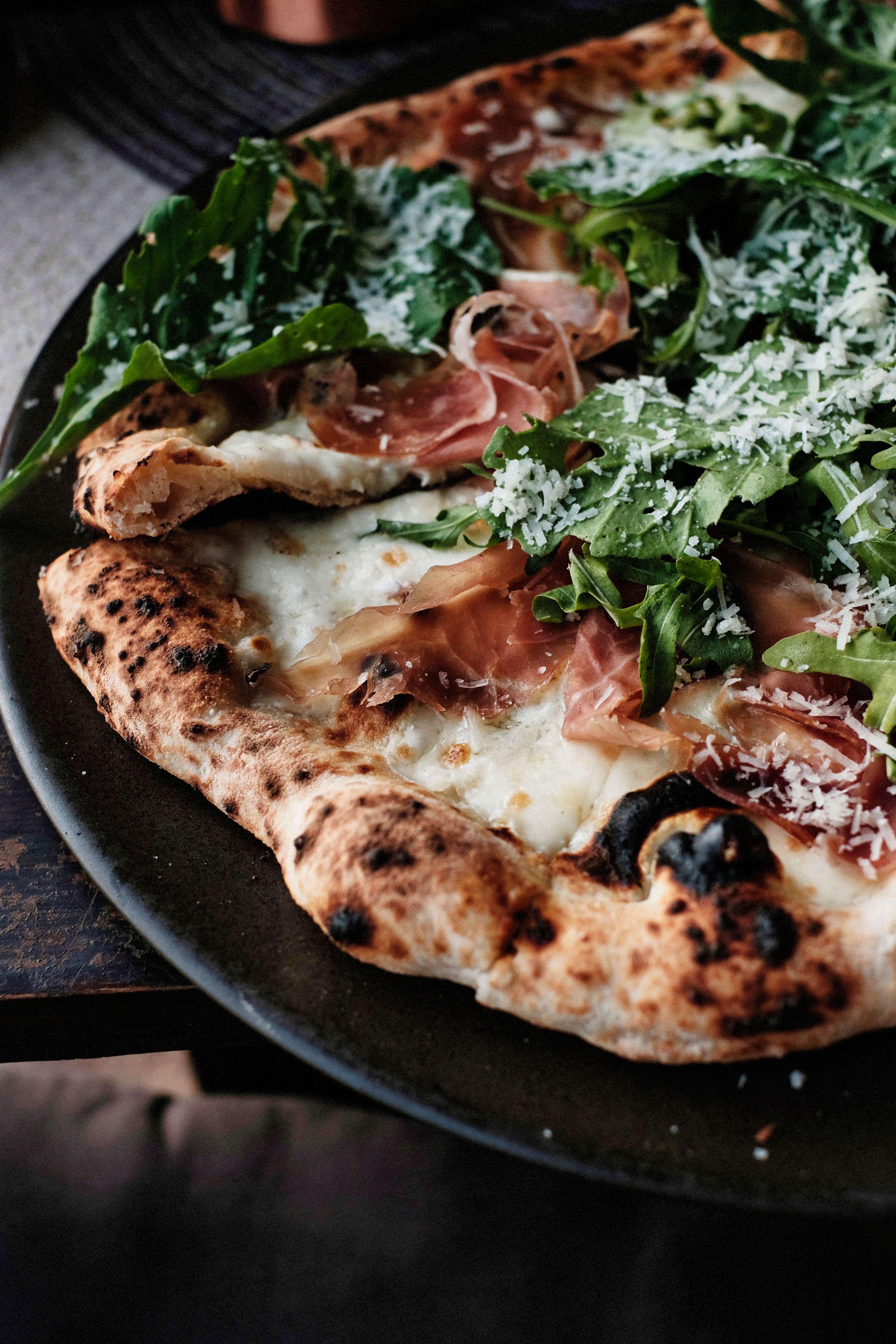Authentic Italian Pizza with Prosciutto and Arugula · Free Stock Photo